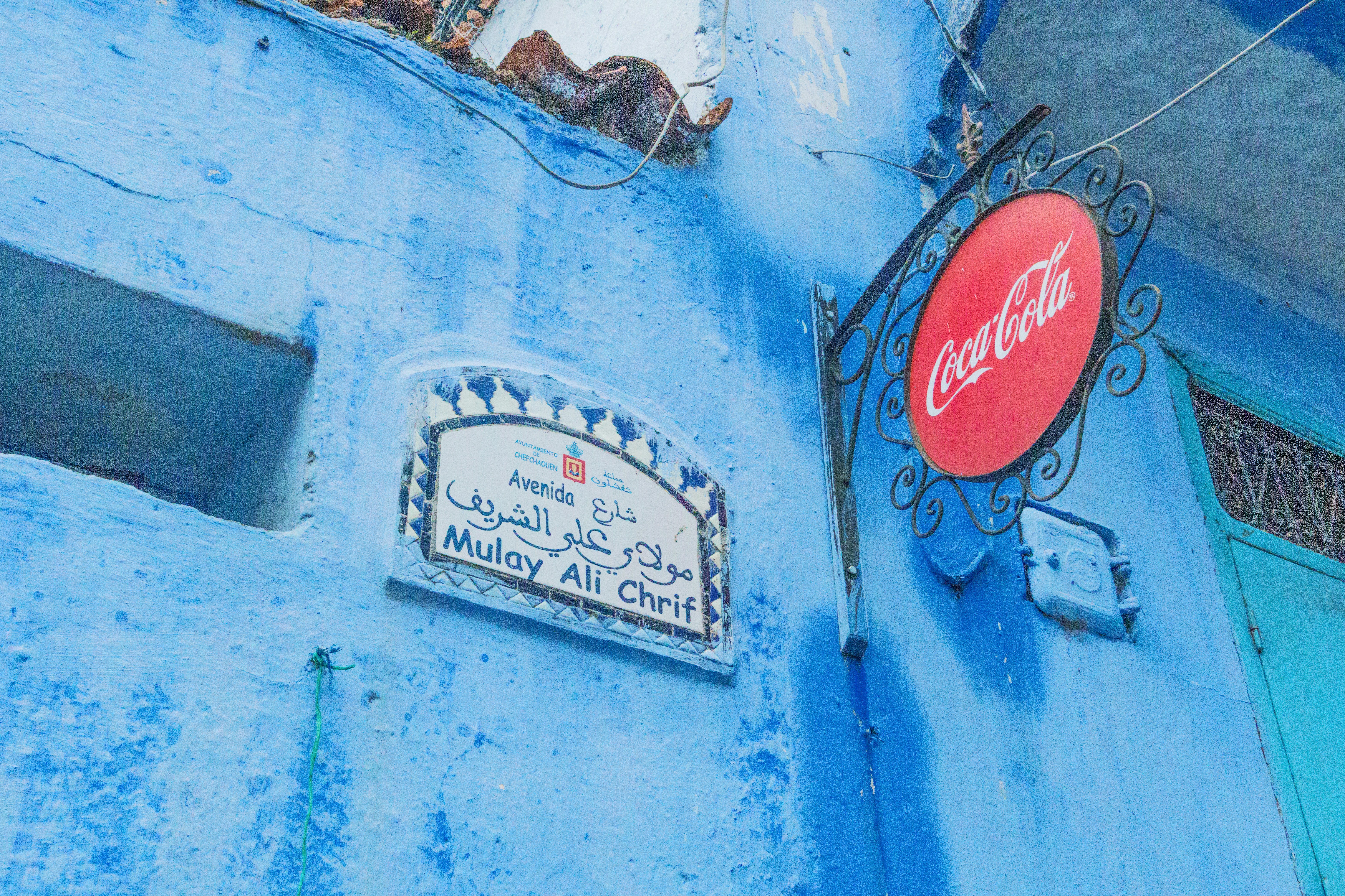 Blue wall with coca-cola sign and street name