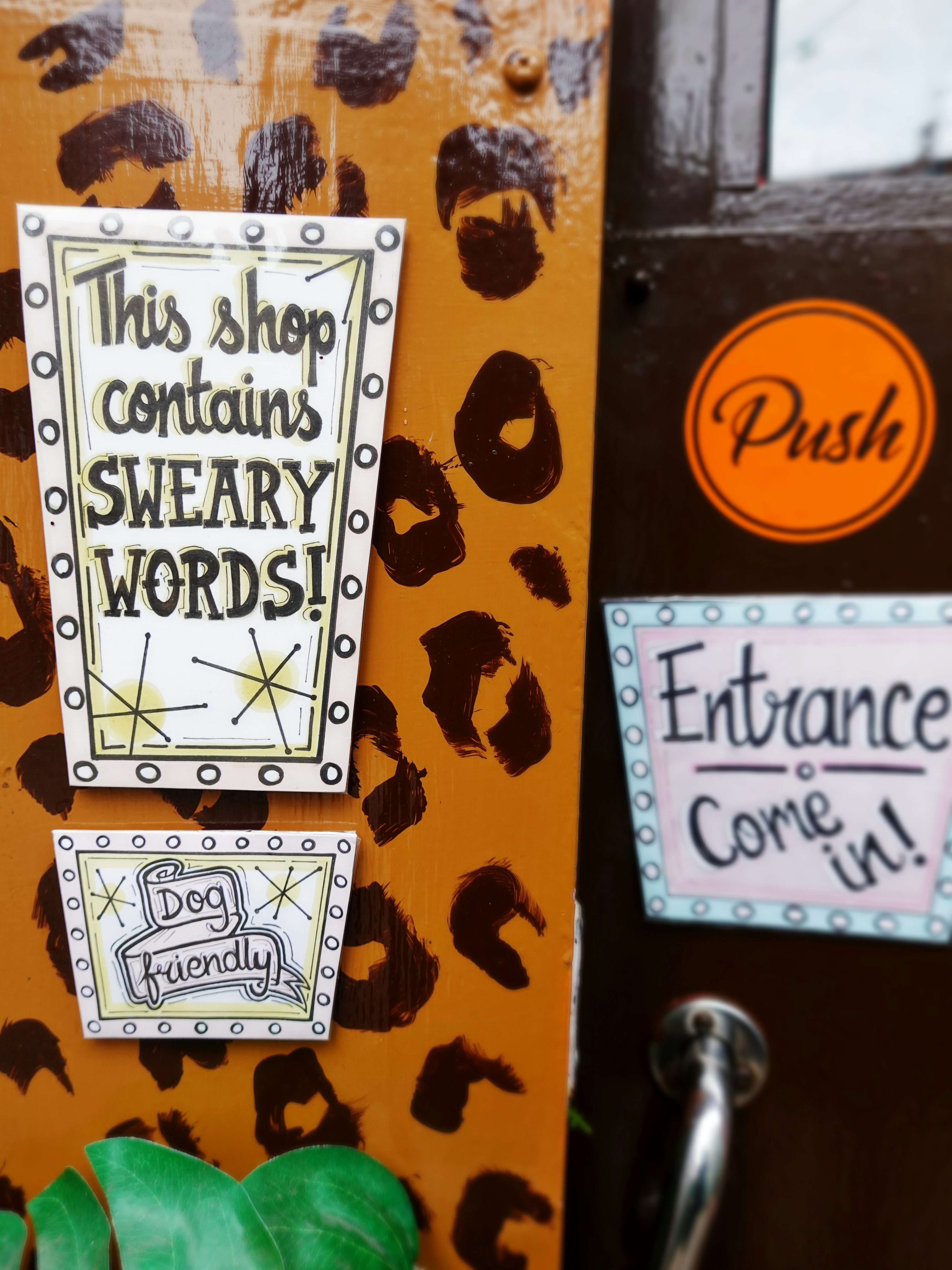 Doorway to Playful Promises: Handwritten Signs on a Leopard-Printed Panel