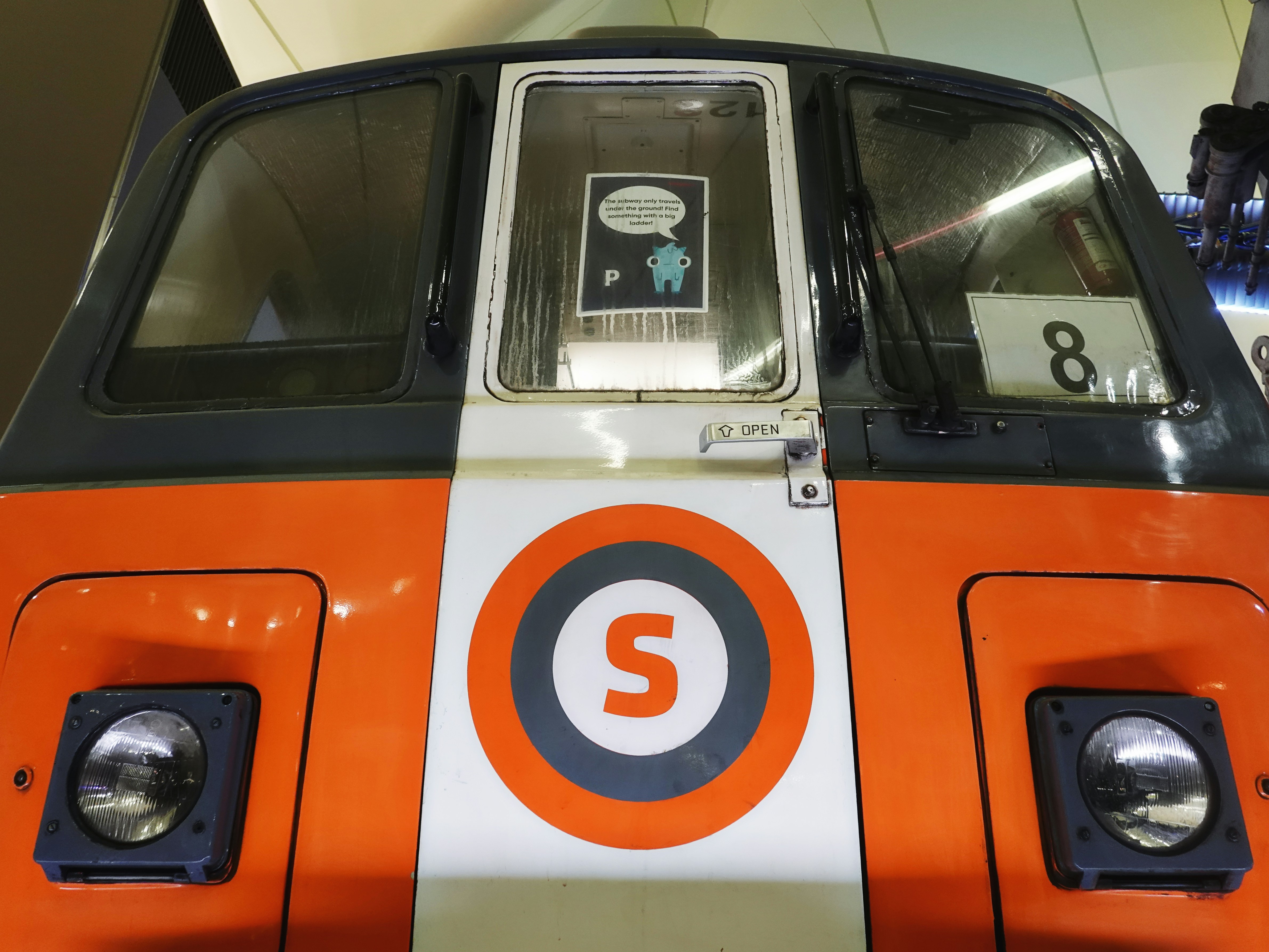 Orange-White S Emblem: A Front View of a Vintage Funicular Vehicle