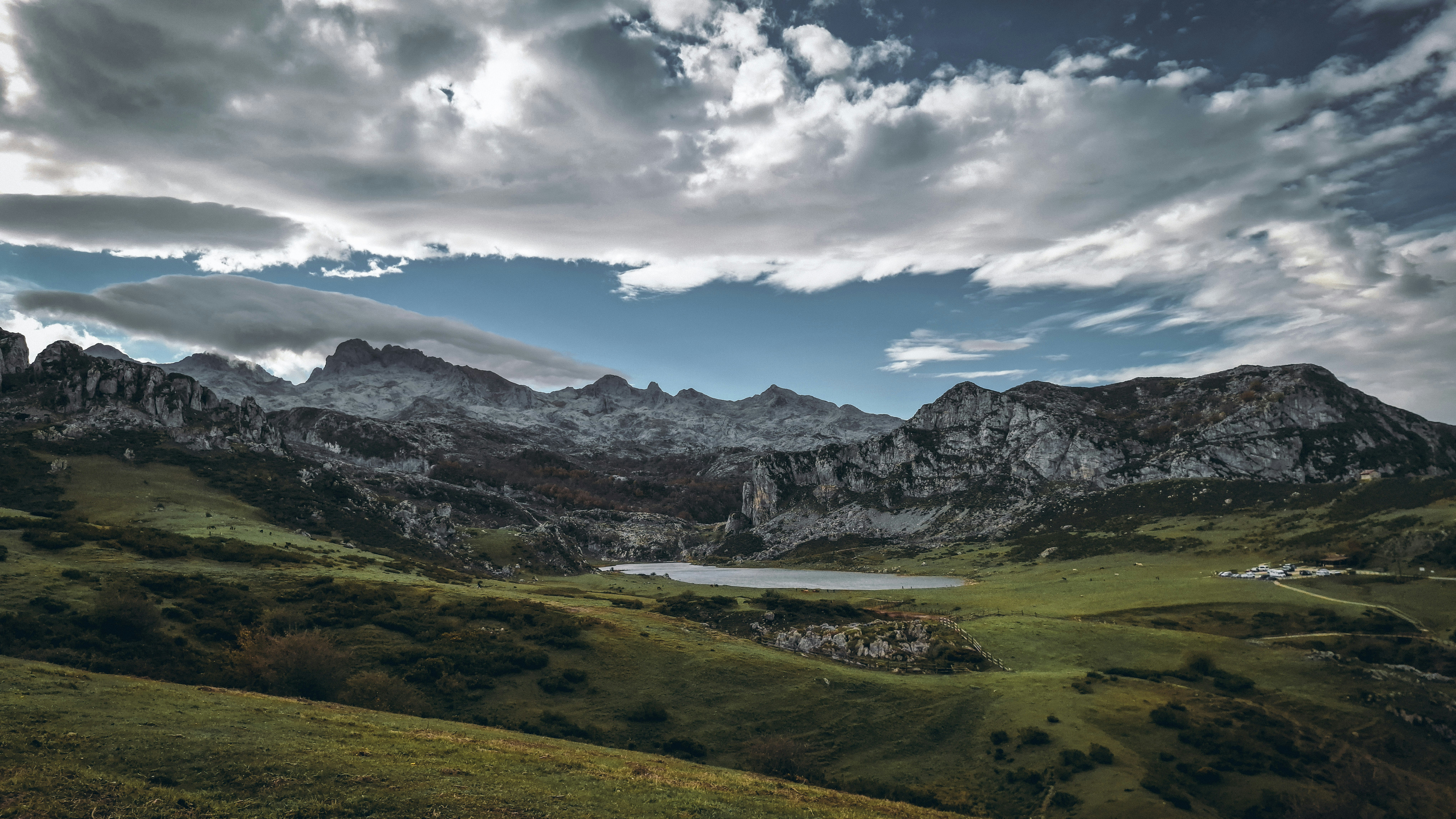 Midday Basin: A Highland Panorama Beneath A Roving Sky