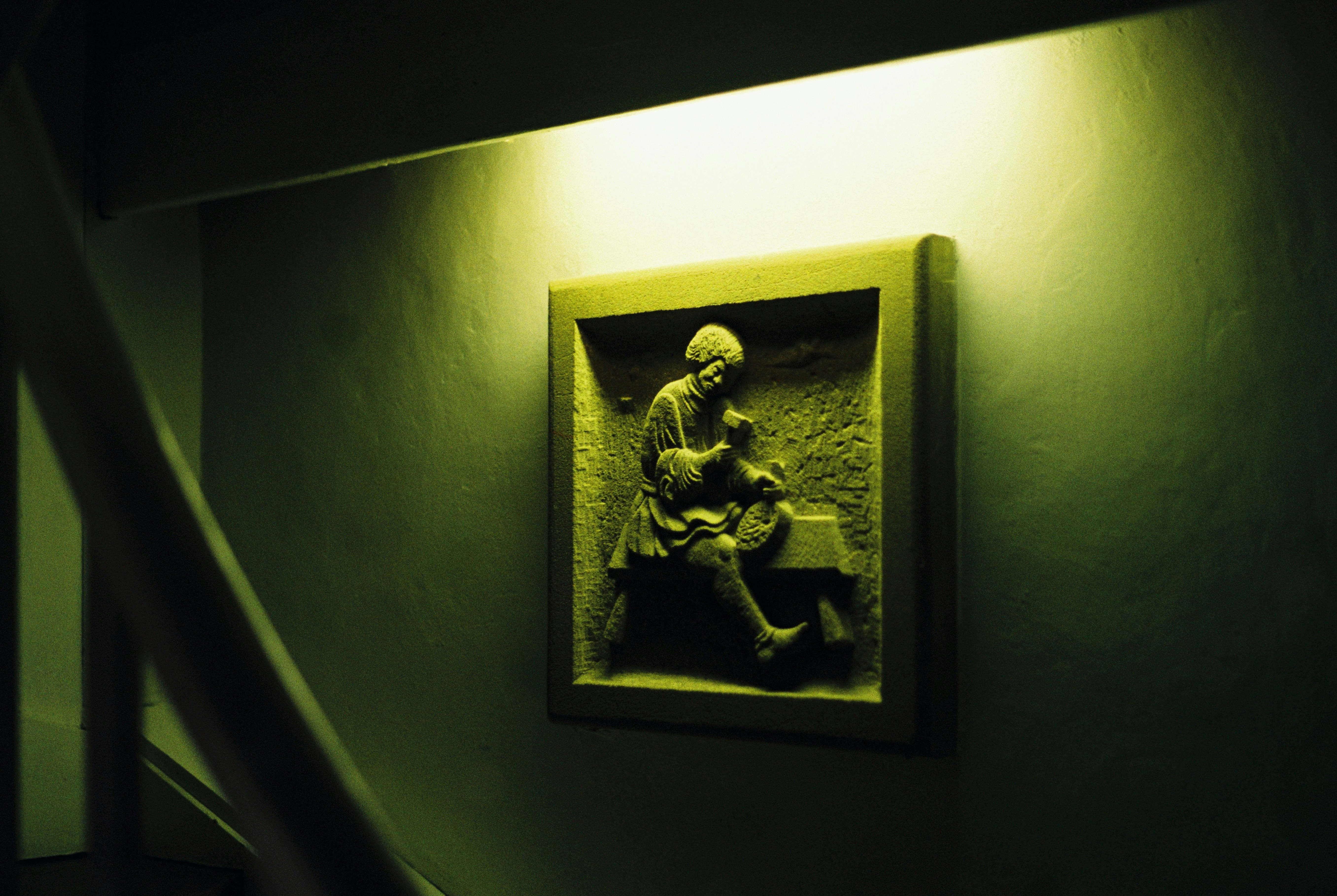 Luminous Relief: A Framed Figure Bathed in Museum-Quiet Green