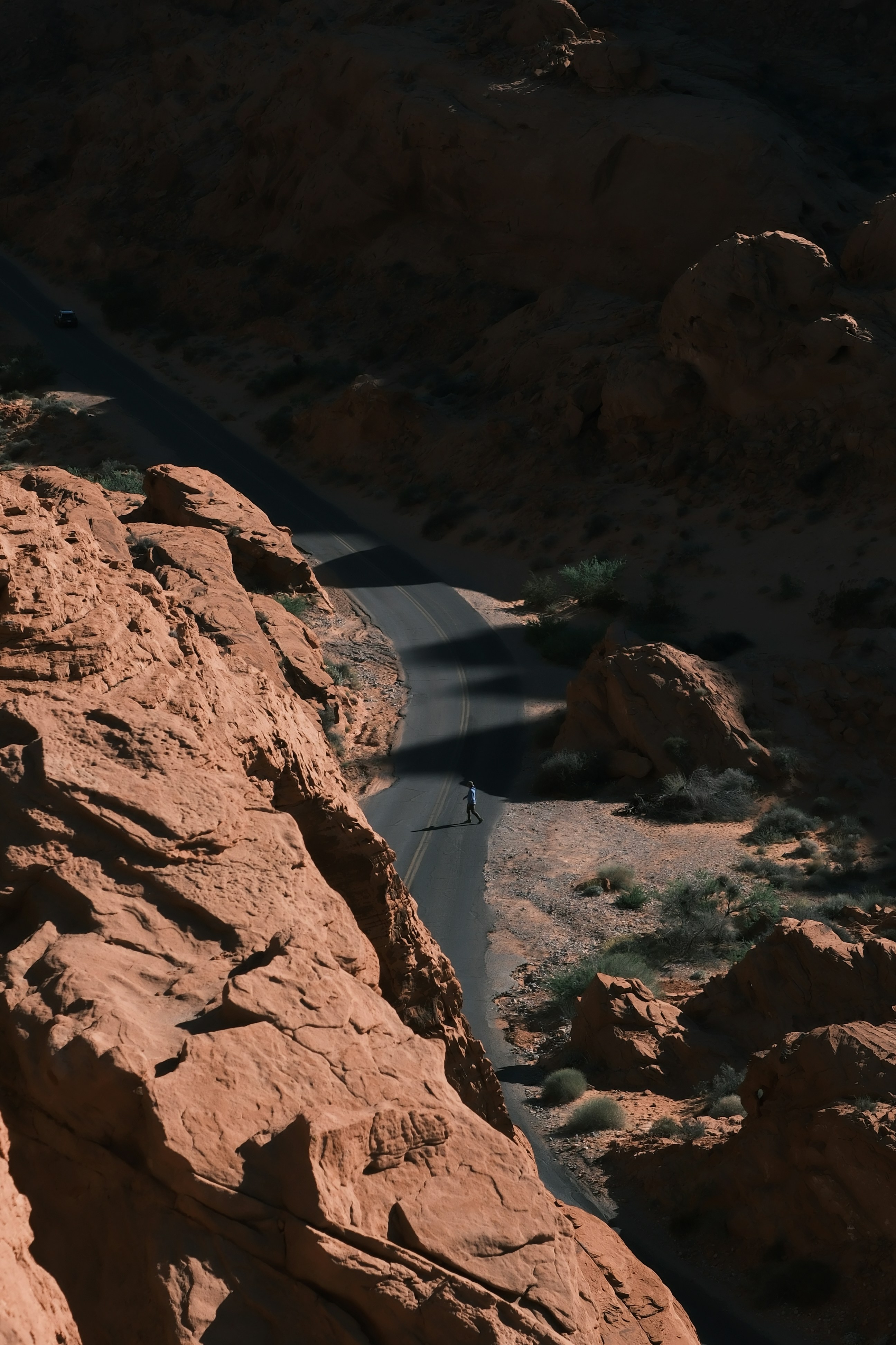 Curved Desert Road: A Lone Hiker among Red Sierra
