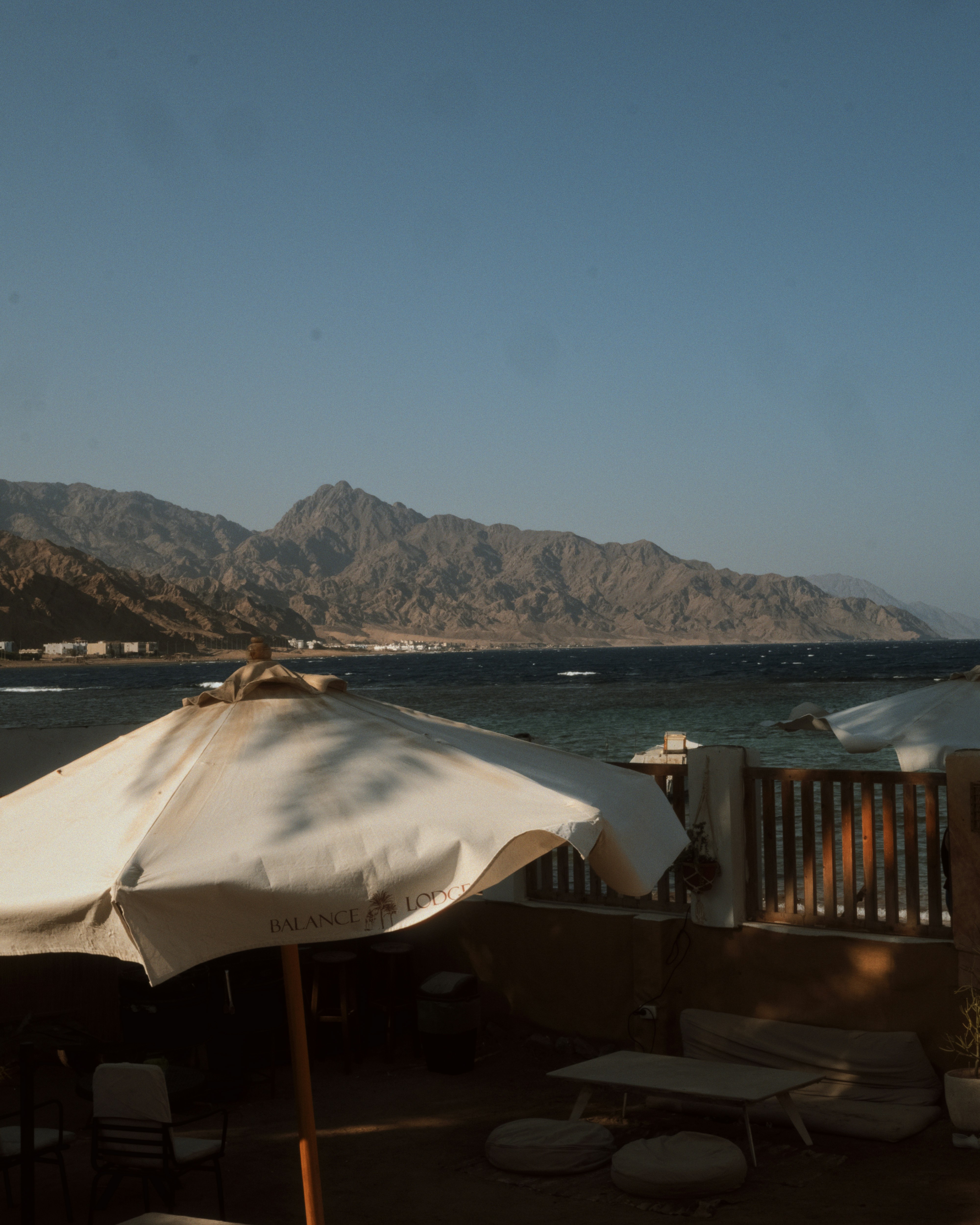 Sunlit Beach Club Under Mountain Ridge