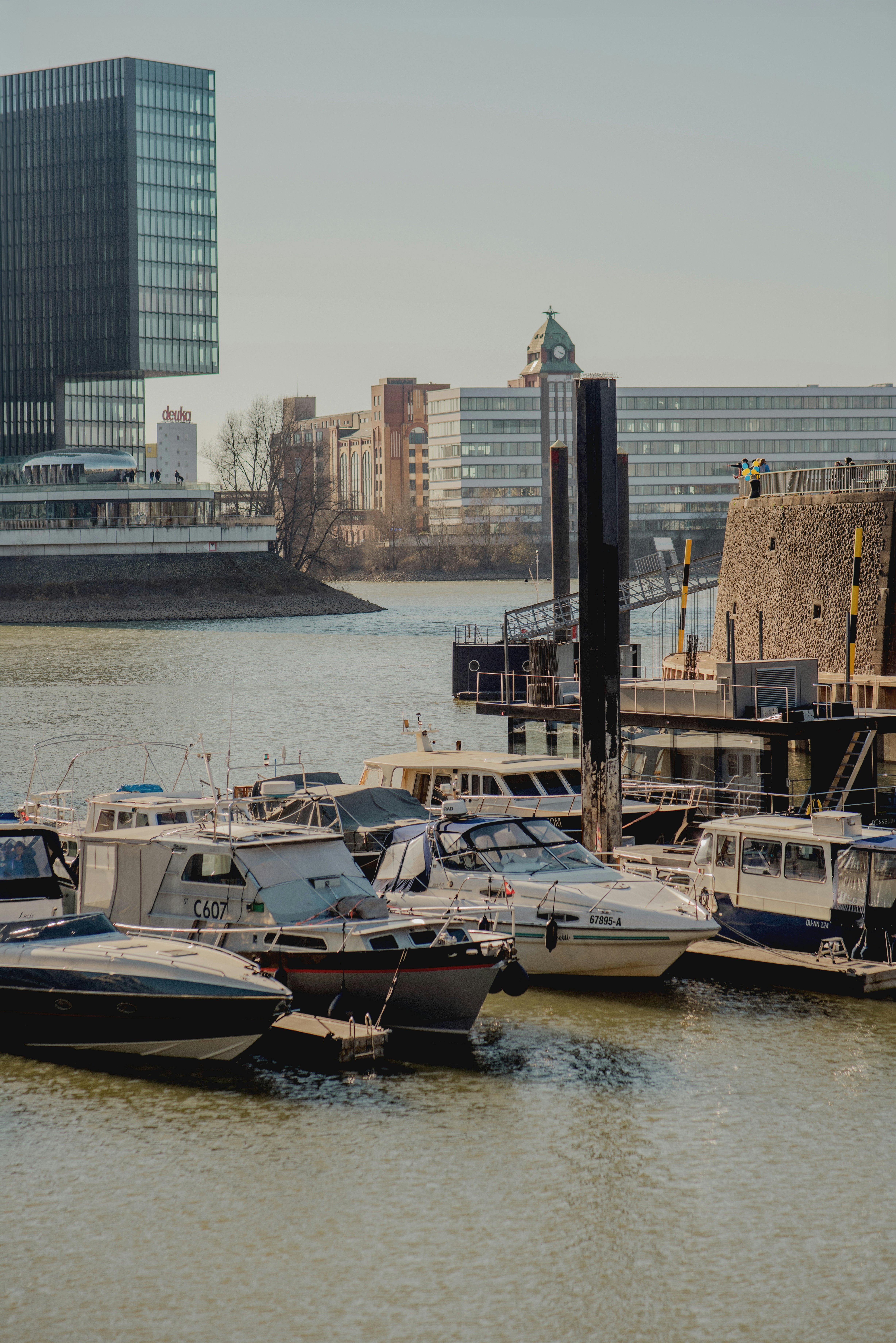 Marina at Dusk: Boats, Dock, and Cityscape