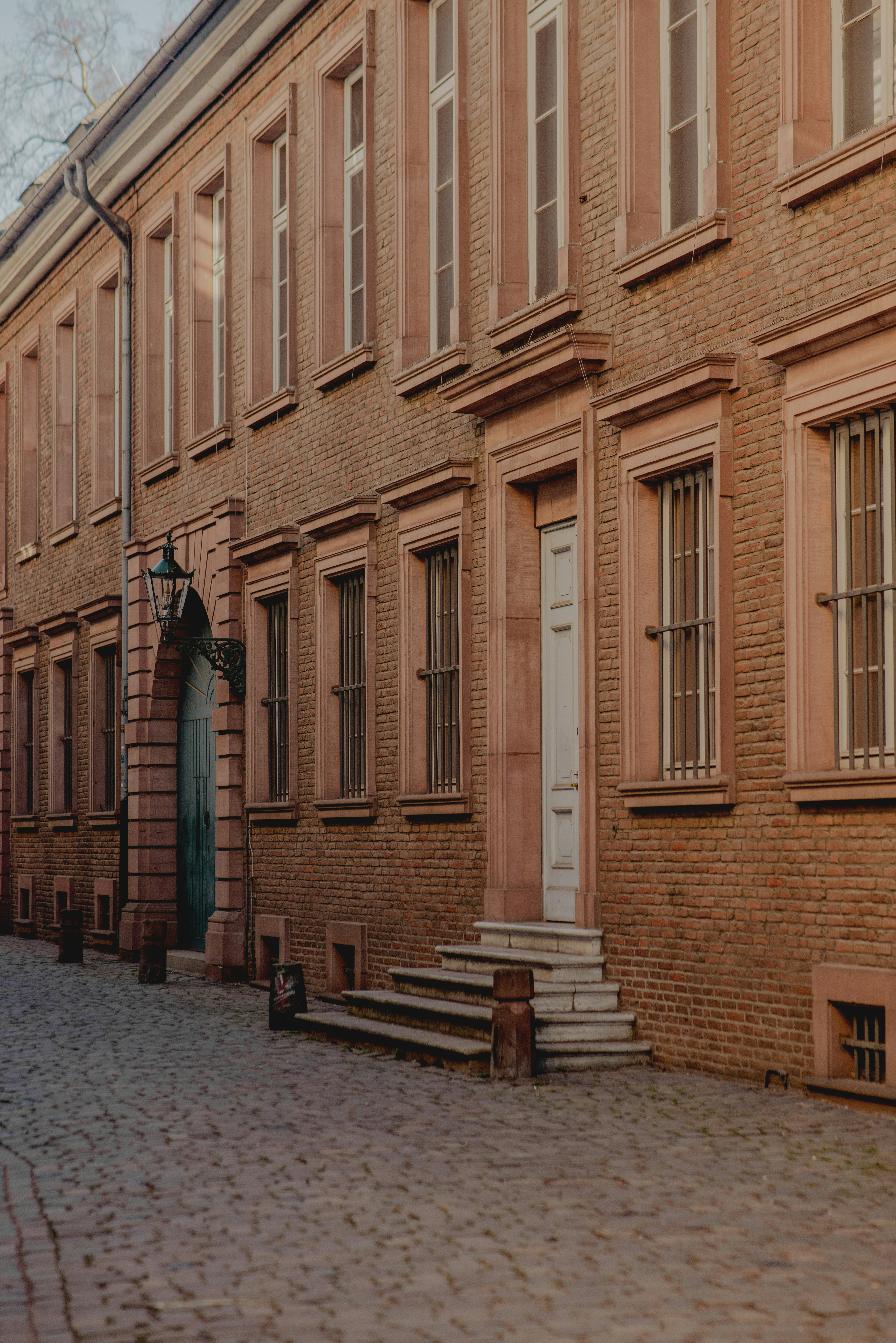 Cobbled Approach: A Quiet Staircase Beside a Brick Townhouse