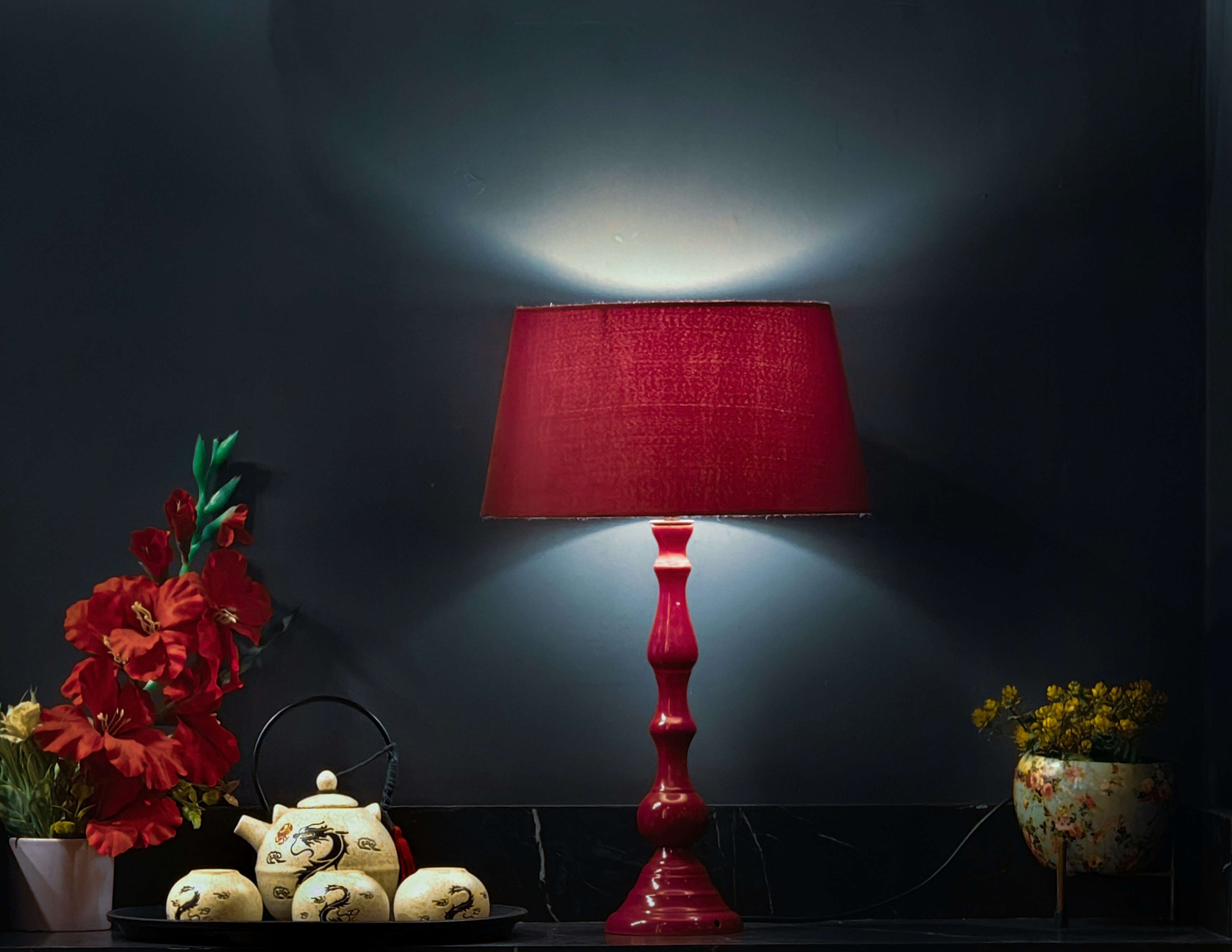Crimson Lamp Casting Silent Glow Over a Floral Still Life