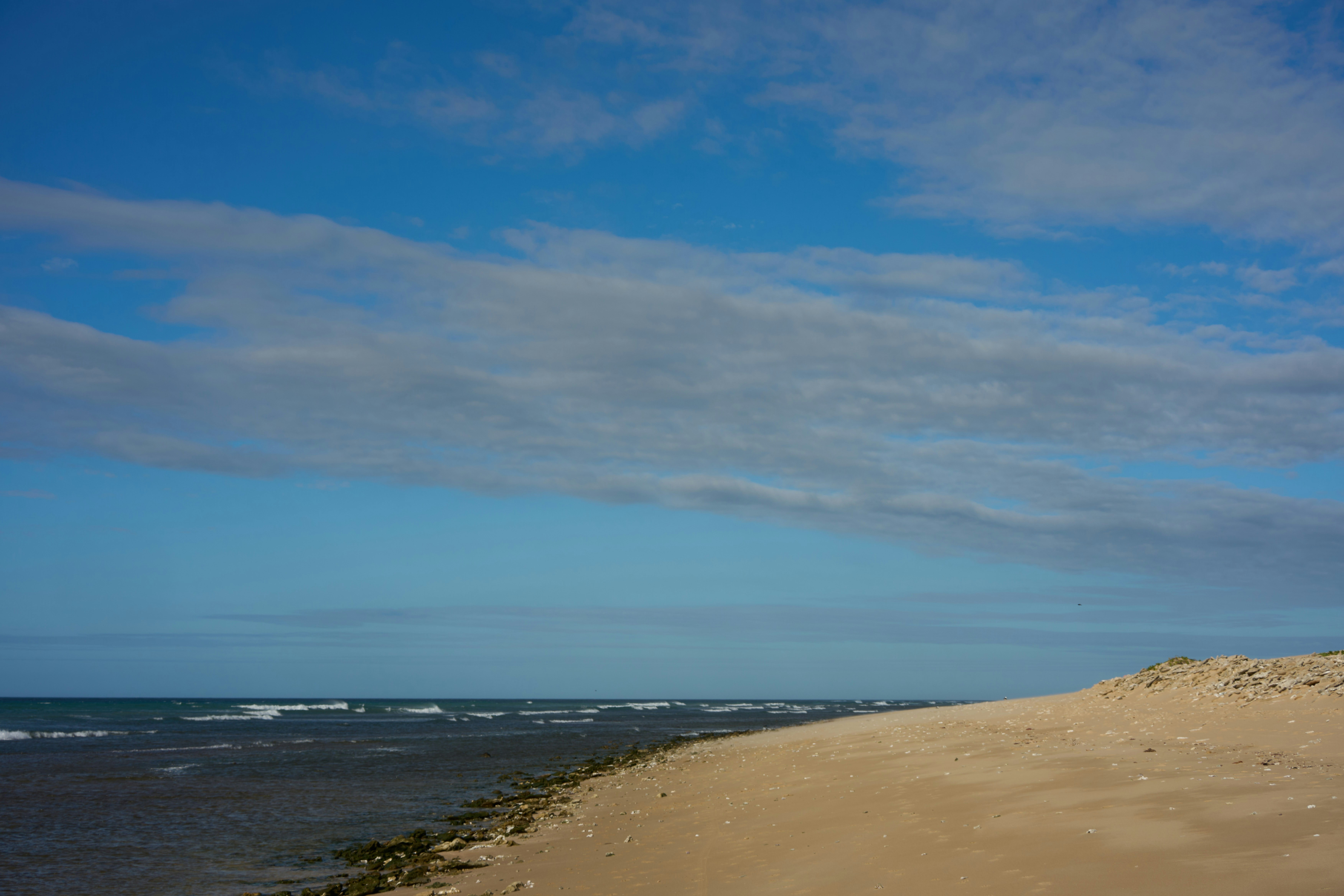 Quiet Coastline Under Expansive Sky