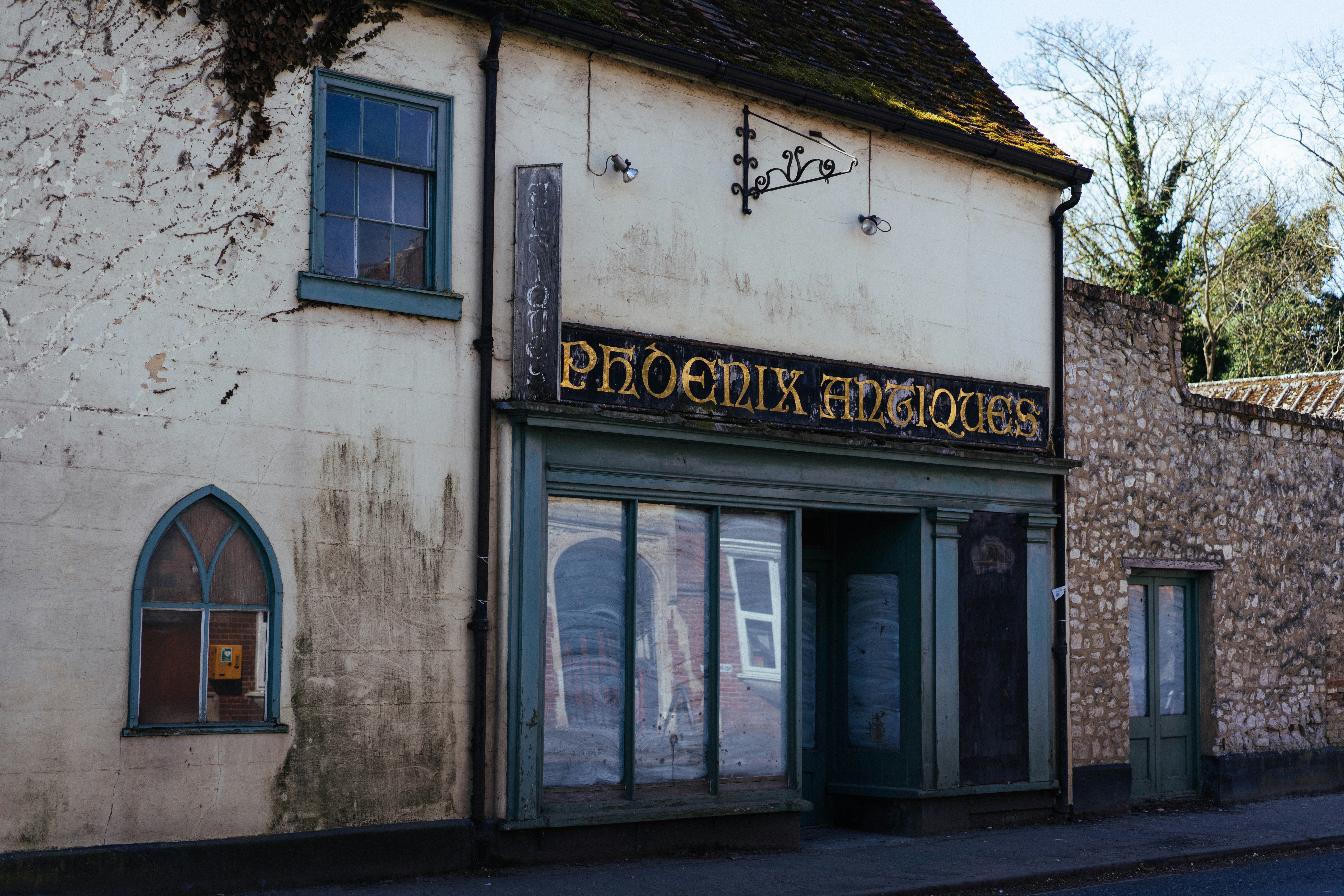 Phoenix Antiques: Weathered storefront with faded charm