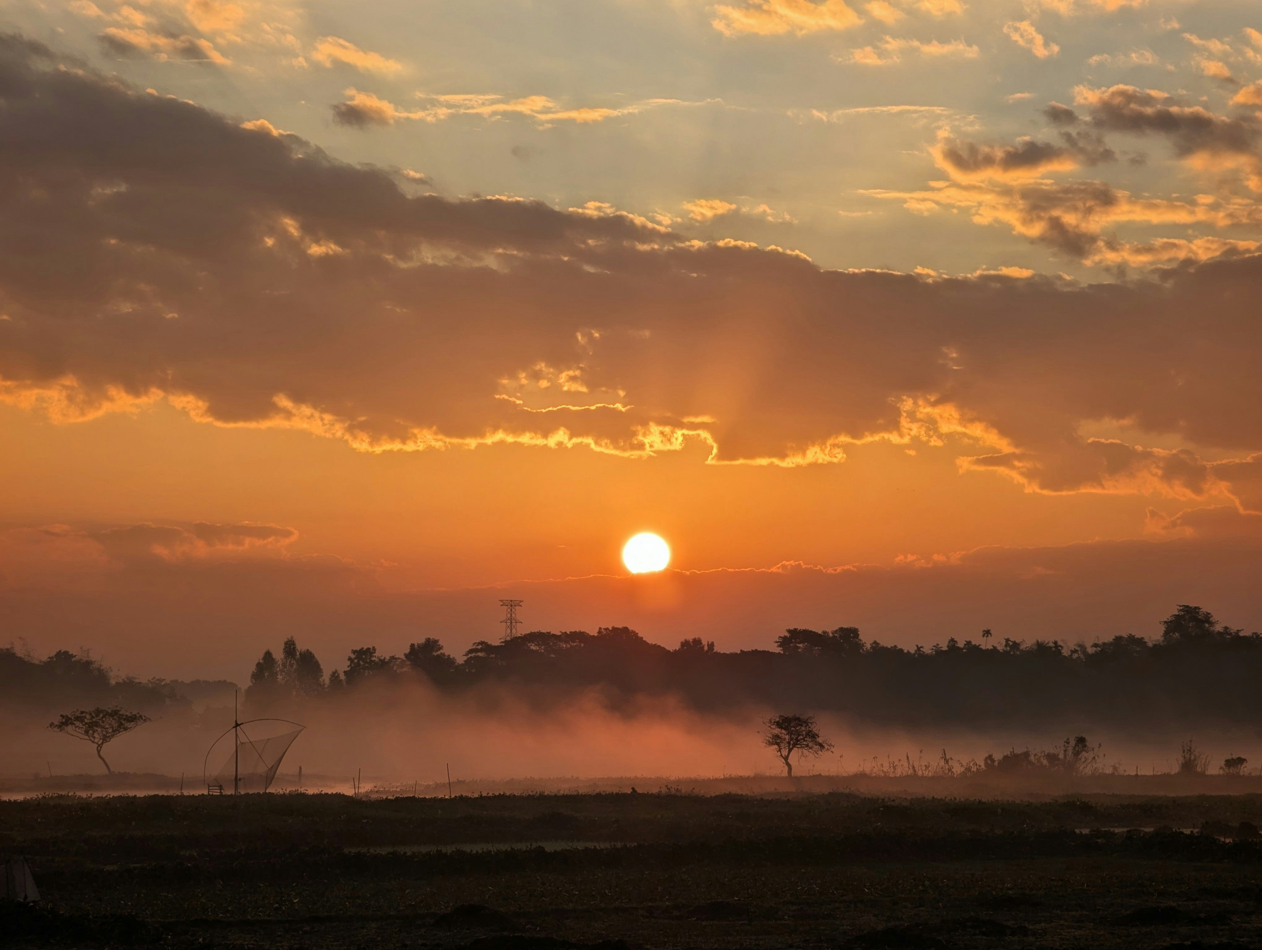 Dawn over Mist-Fed Fields: Rising Sun on Quiet Plains