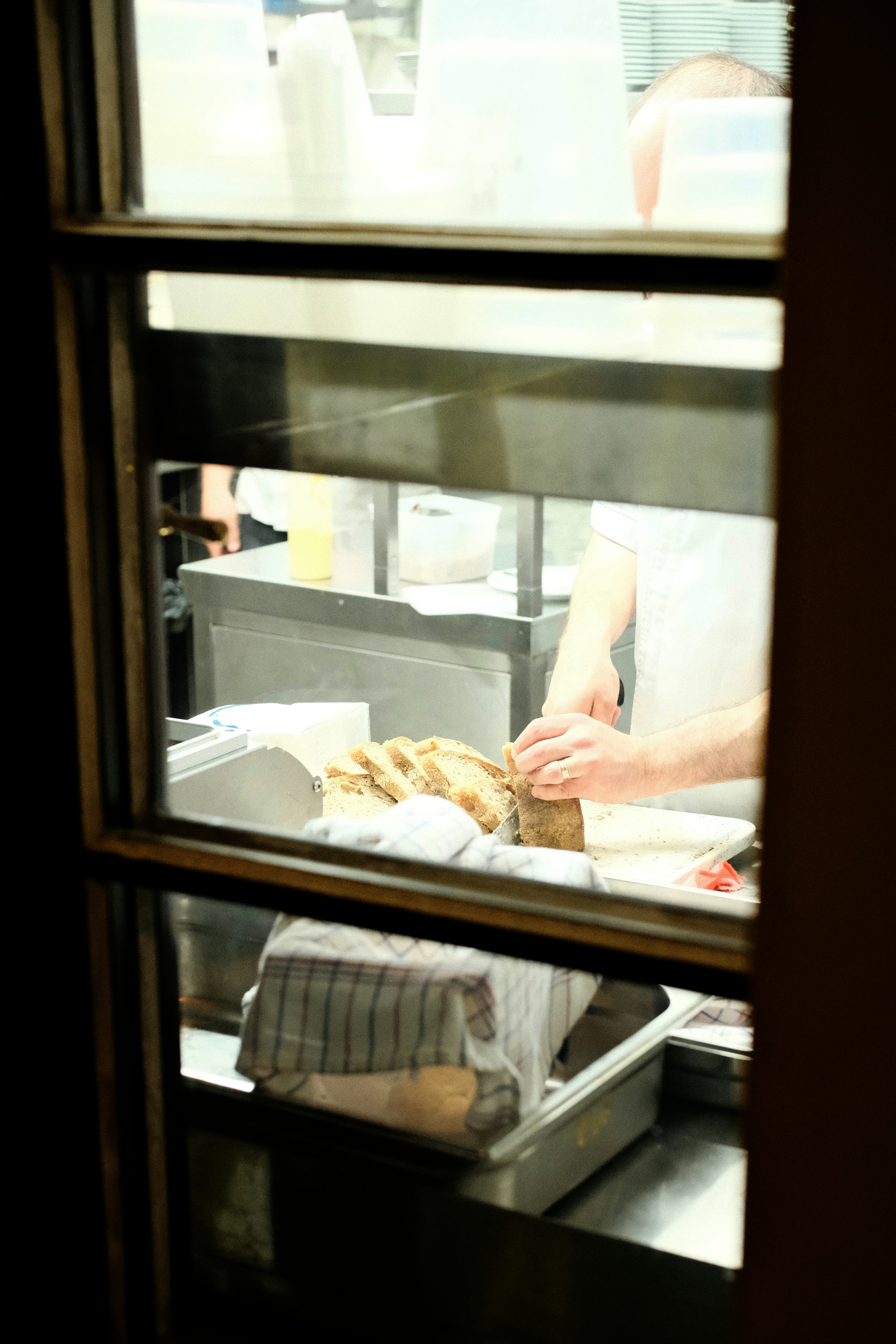 Slice of Service: Hands at Work on the Sliced Loaf