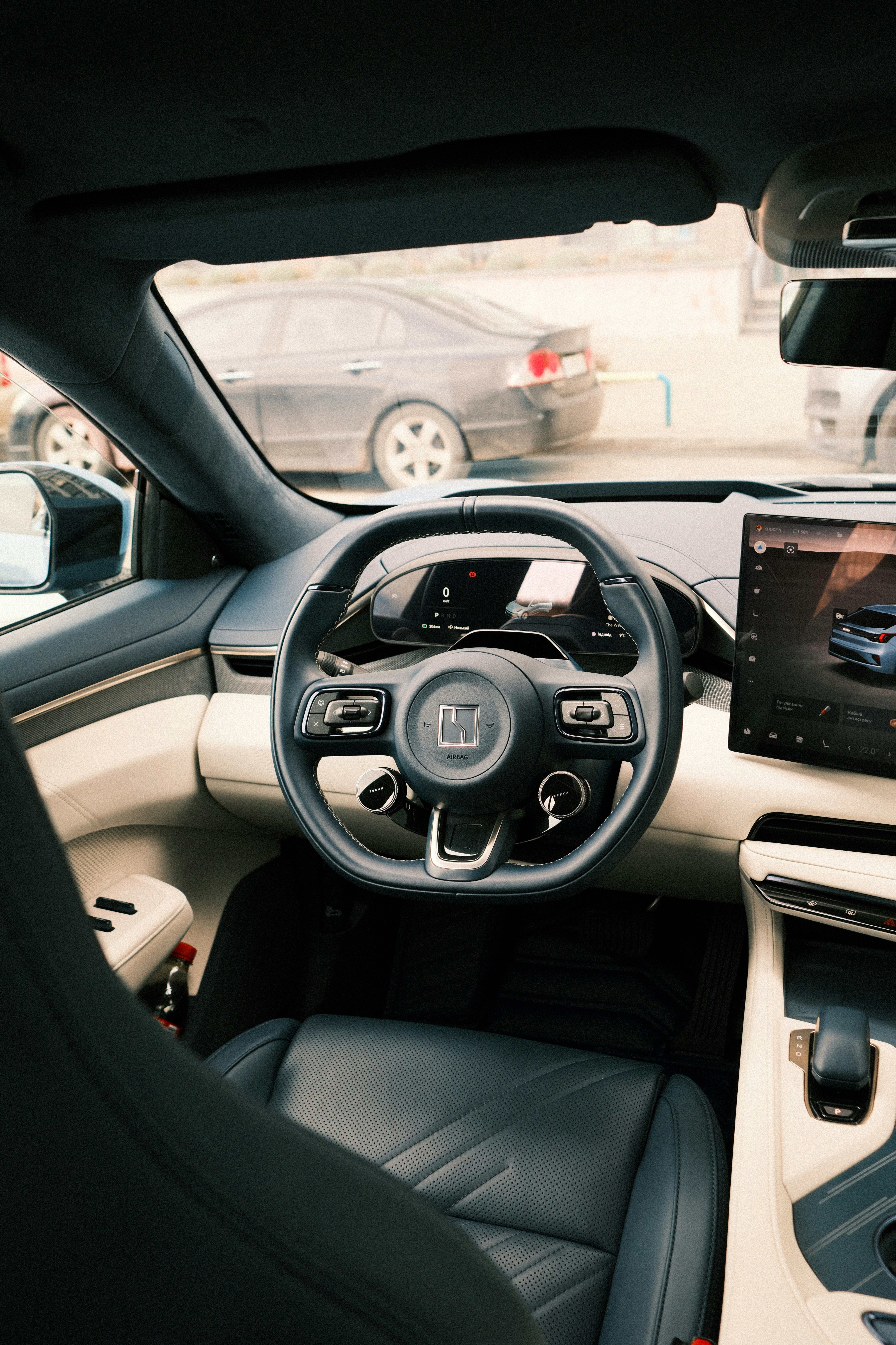  cockpit centerpiece: steering wheel and digital dash in a modern car cabin