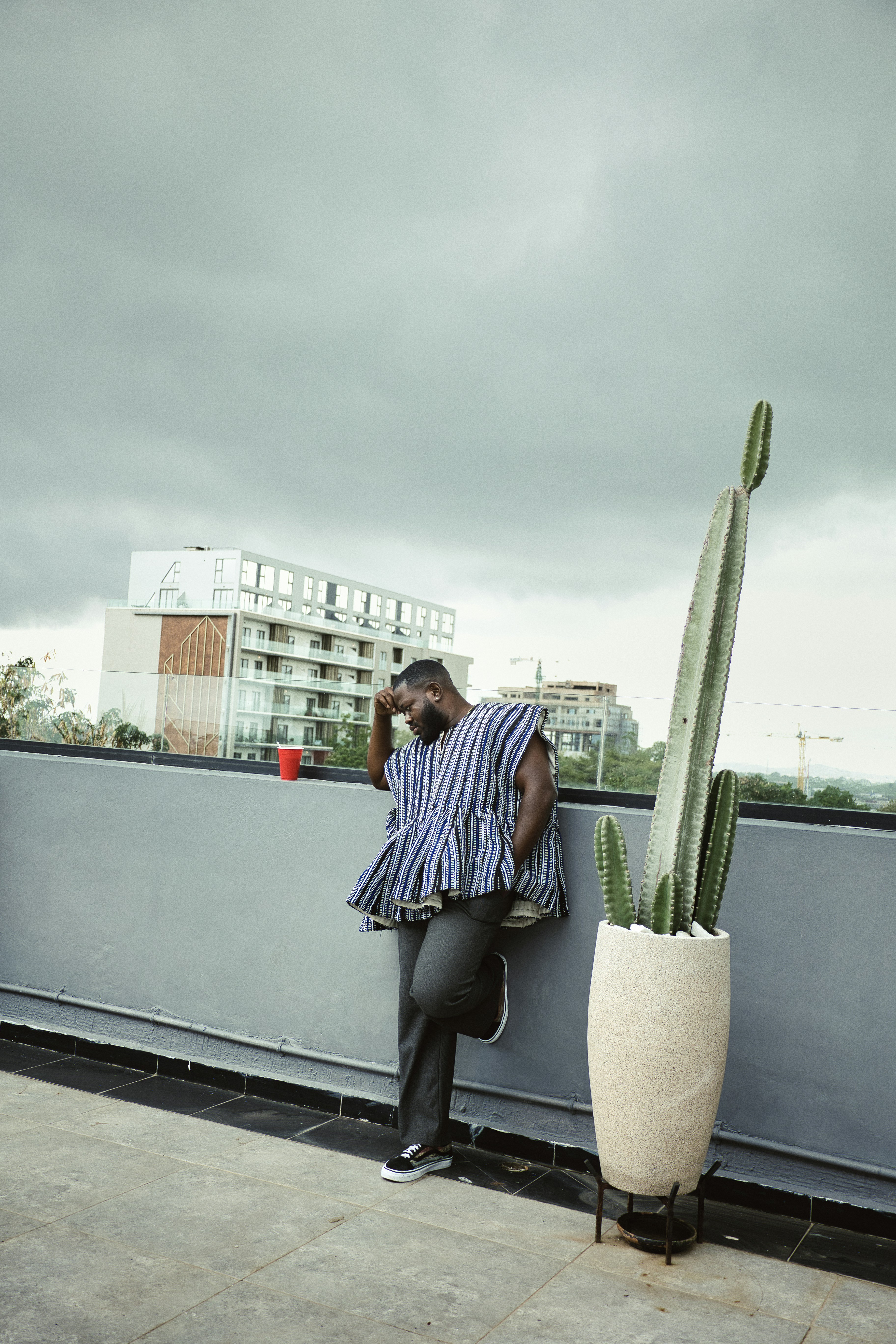 City Rooftop Moment: A Quiet Pause with a Tall Cactus