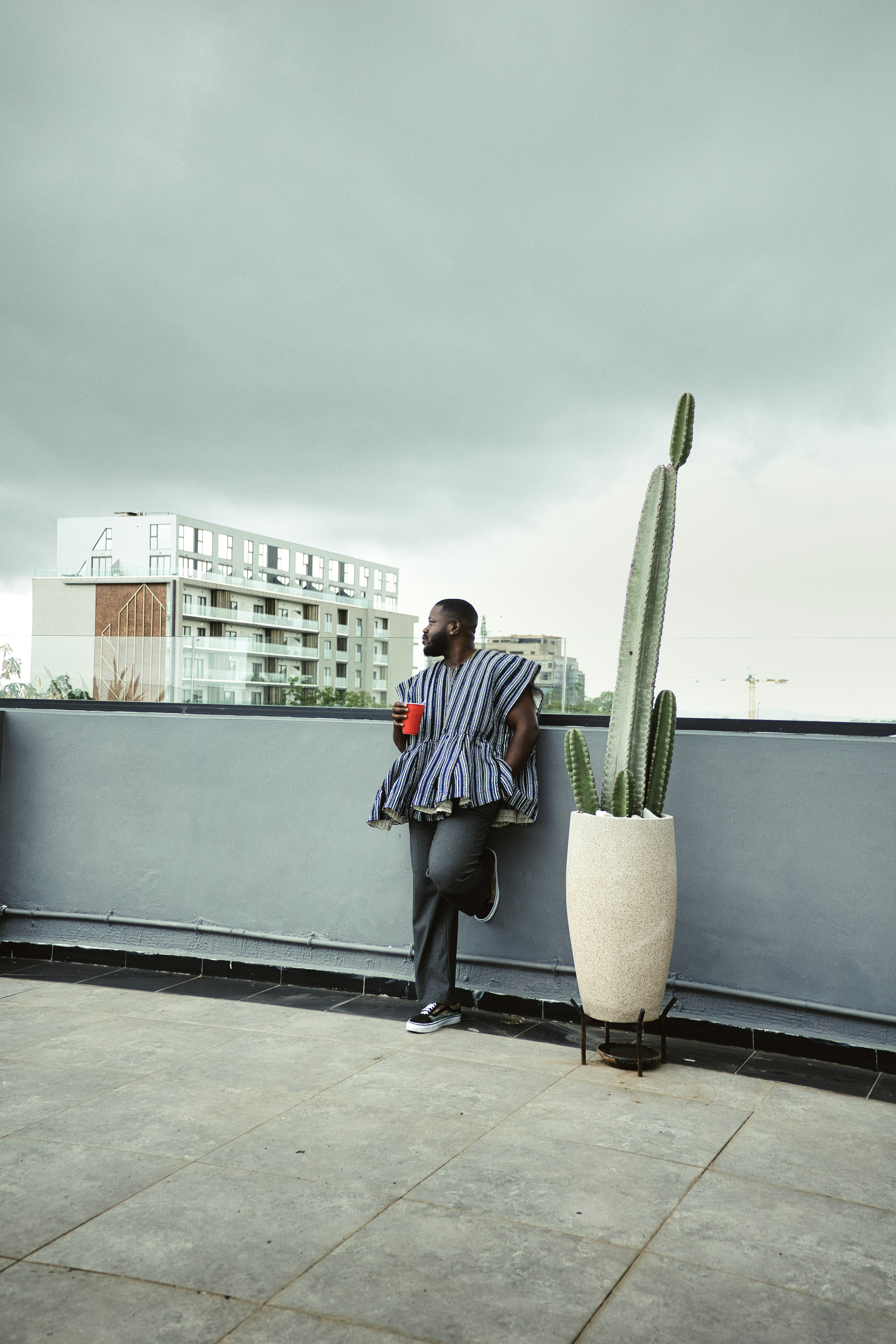 Rooftop Moments: Stride and Stillness by the Cactus