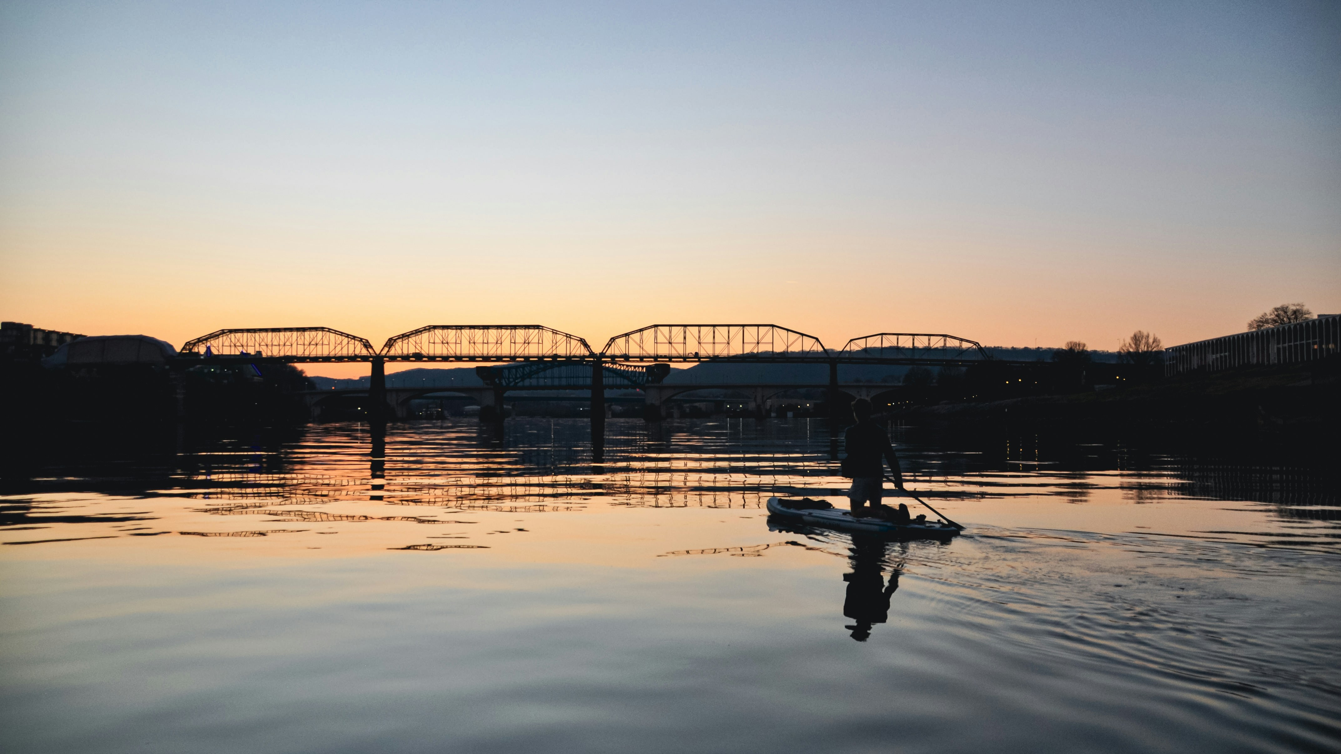 Dusk on the River: Silhouettes and Steel Arches