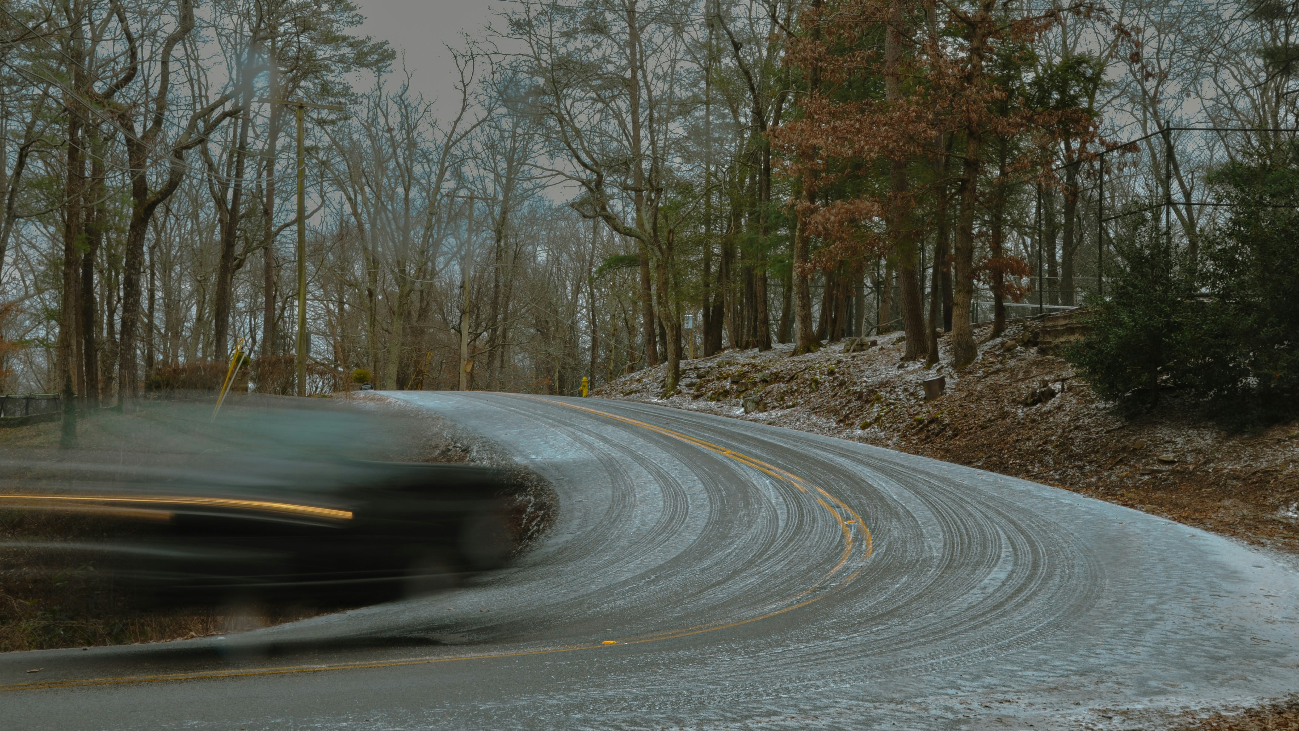 Midwinter Curve: A Car Whips Through Icy Bend