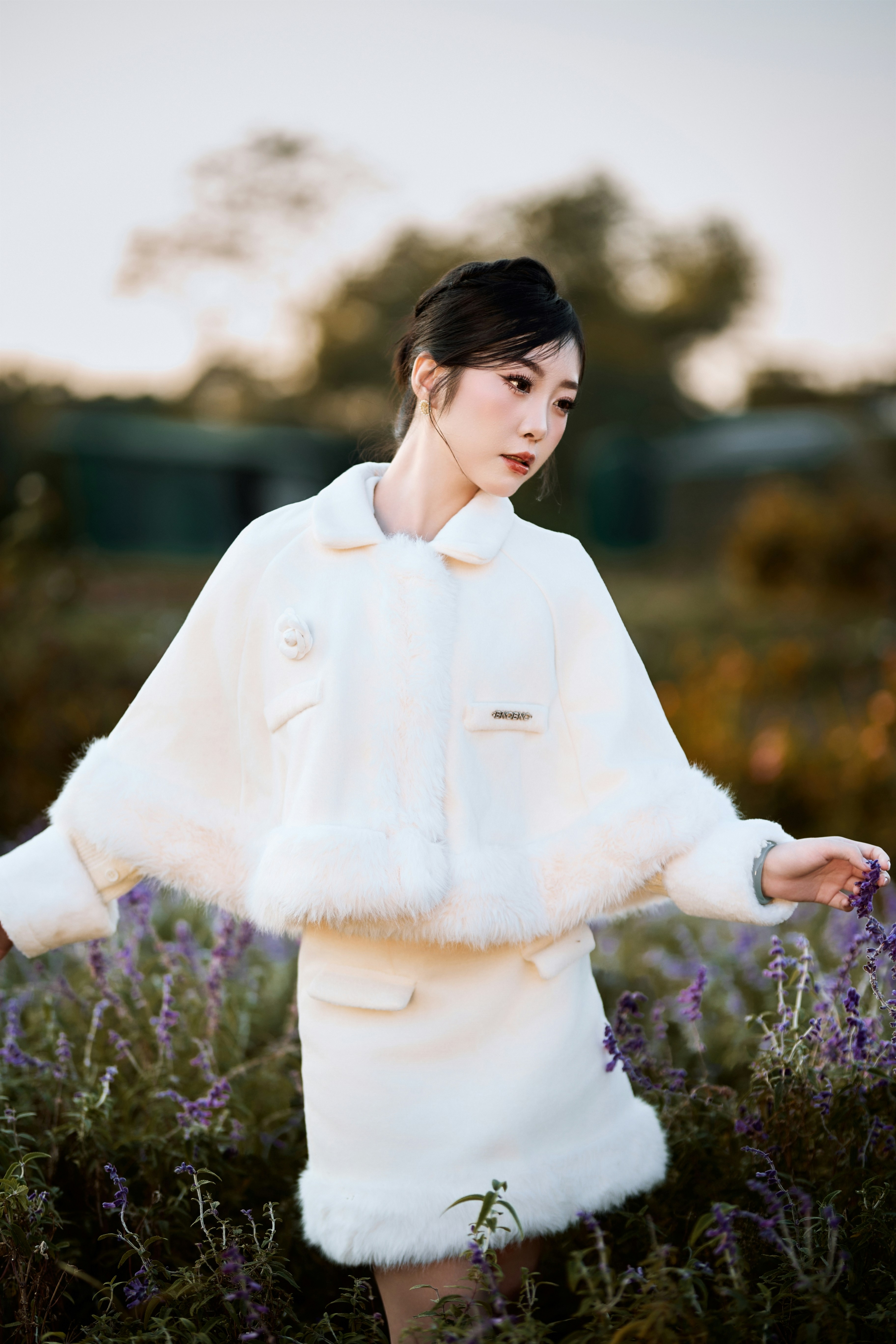 Winter White: Poised Portrait Amid Lavender Blooms