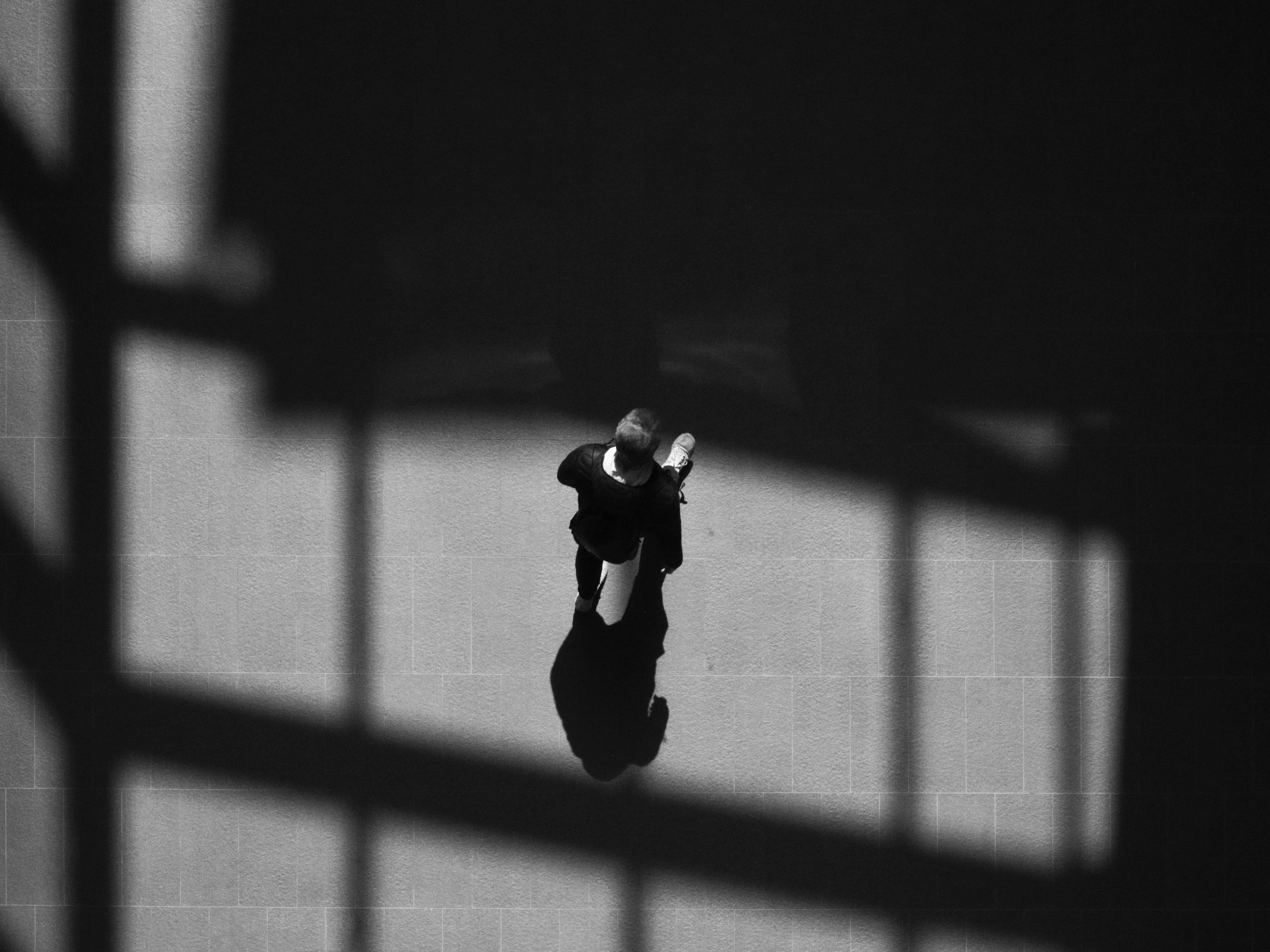 Shadowed Descent: A Solo Figure in Geometric Light