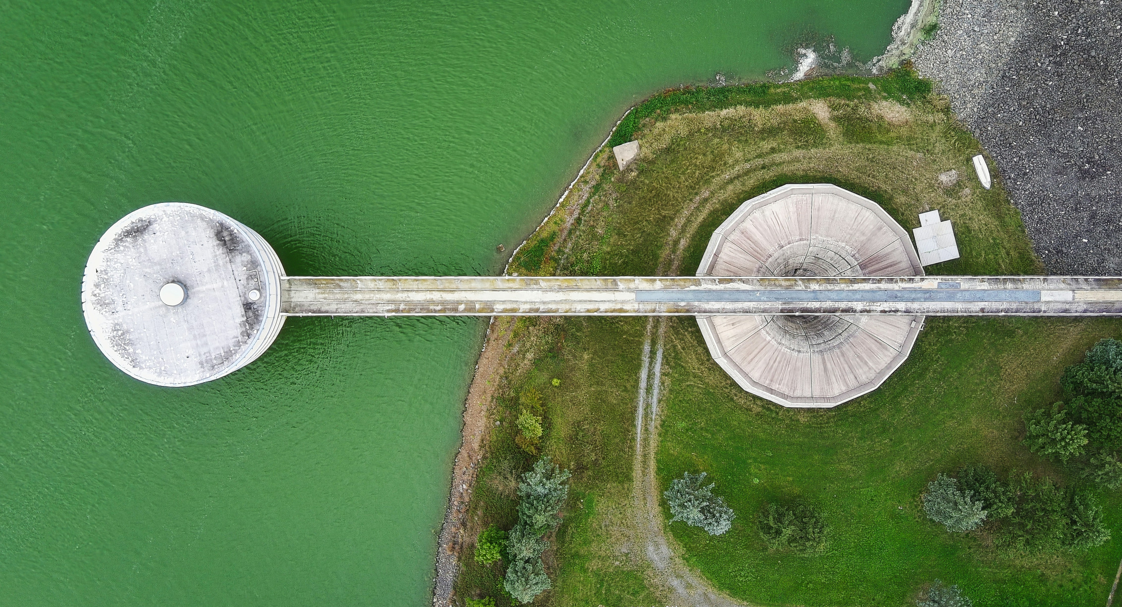 Bridge to the Circular Platform: Aerial View of a Waterfront Walkway