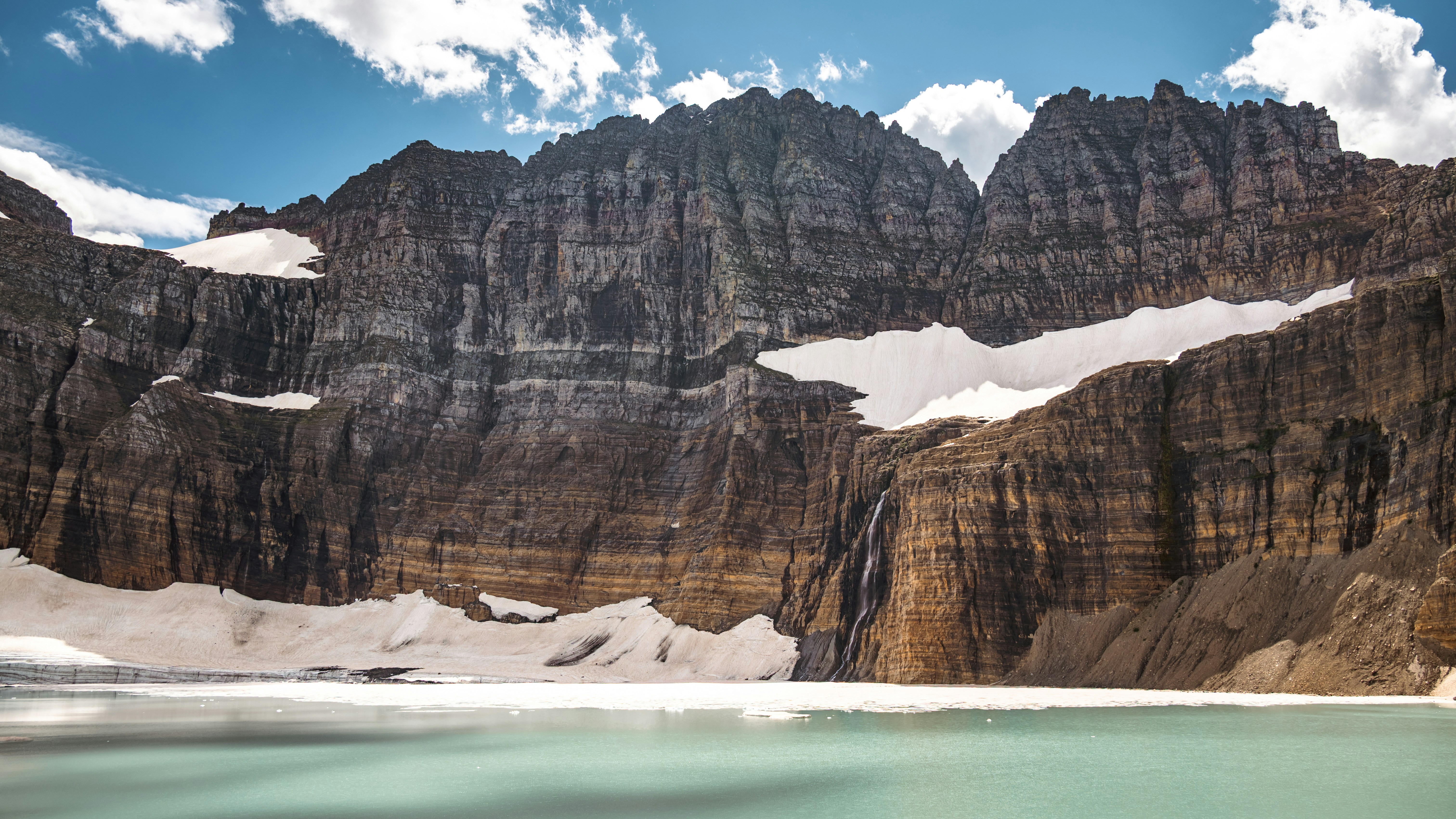 Emerald Lake in a Snow-milled Basin beneath Craggy Peaks
