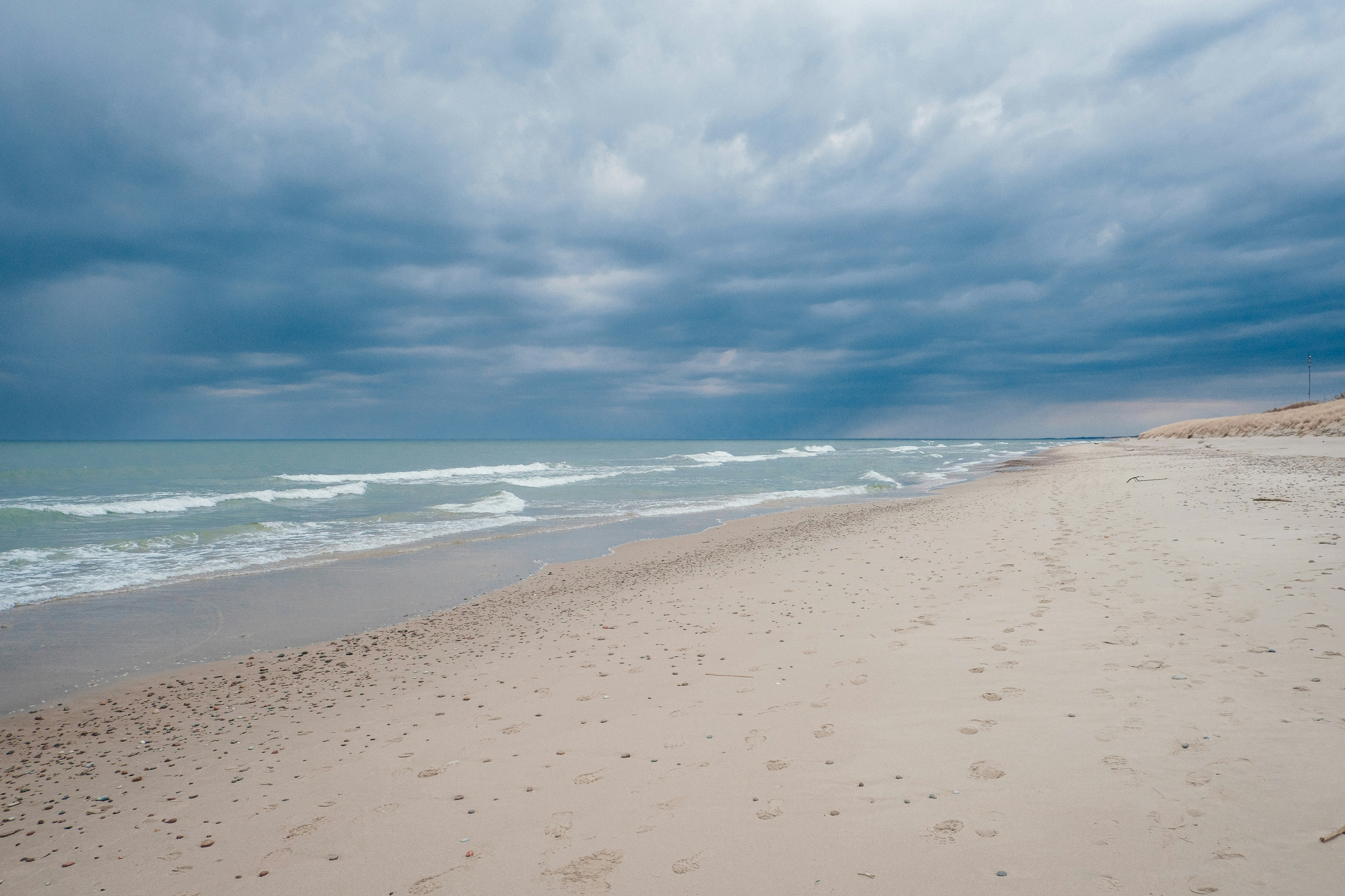 Deserted shoreline under brooding skies