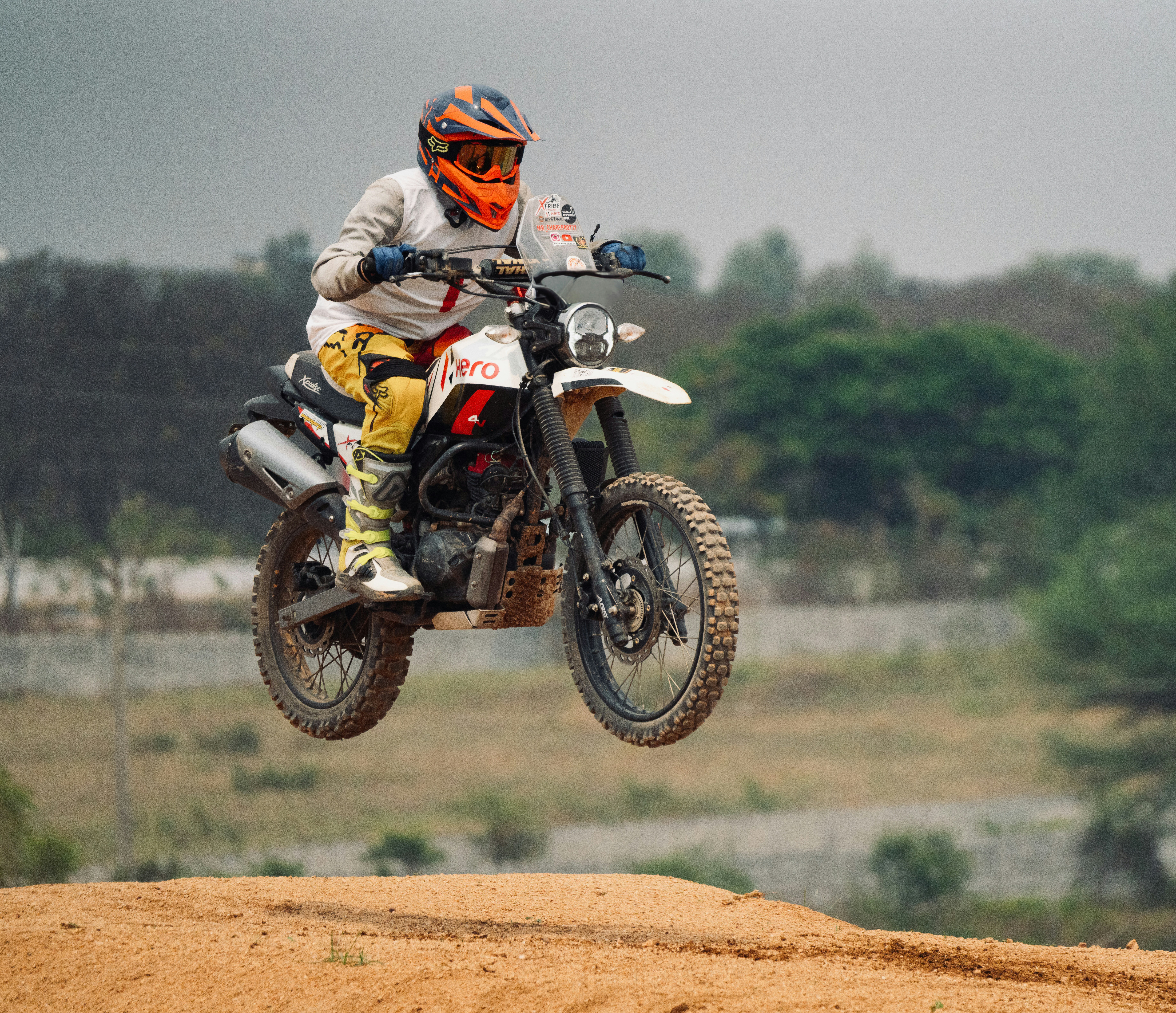 Mid-Air Rally: Rider in a Mud-Splashed Leap
