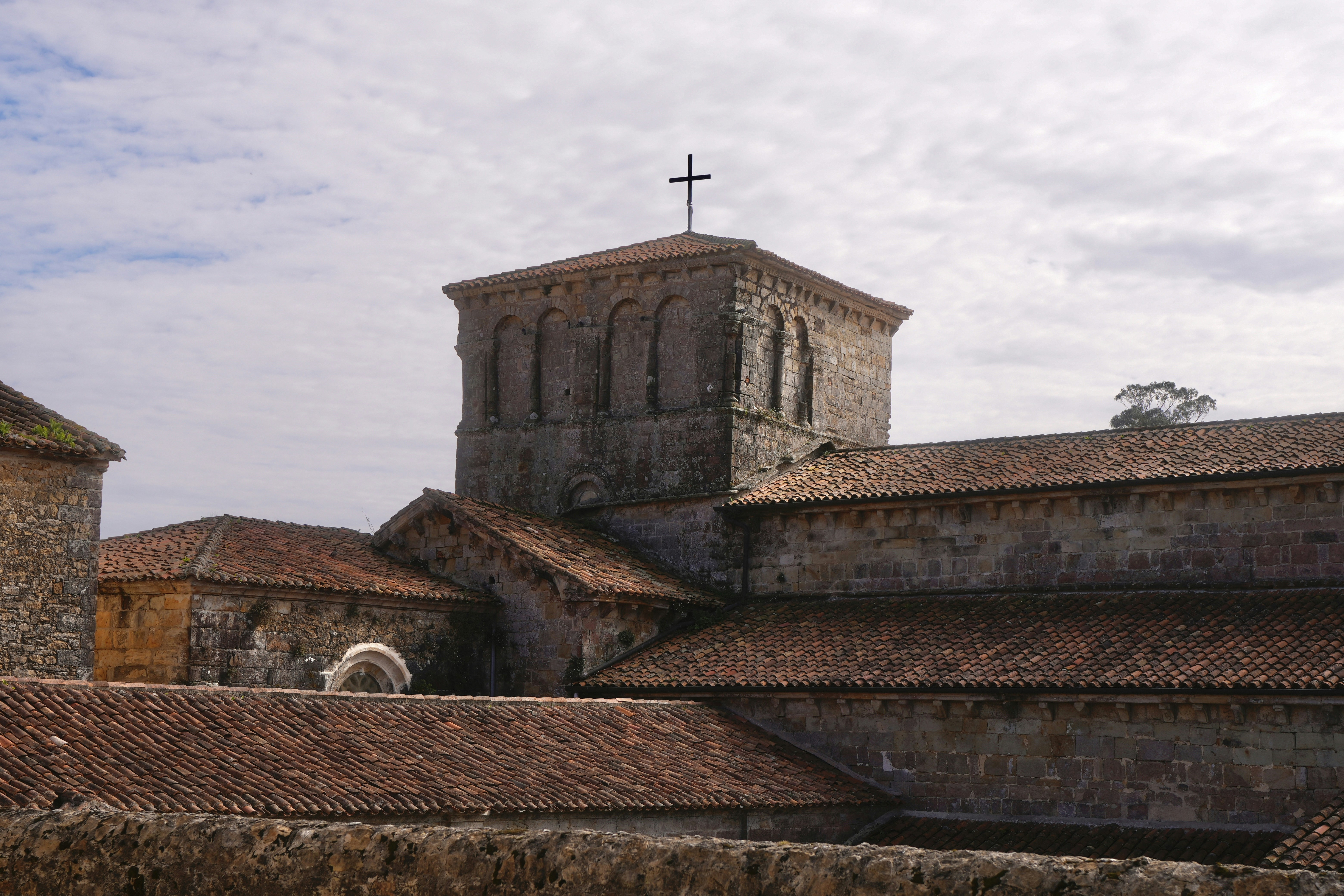 Stone Chapel Rising from Weathered Rooflines