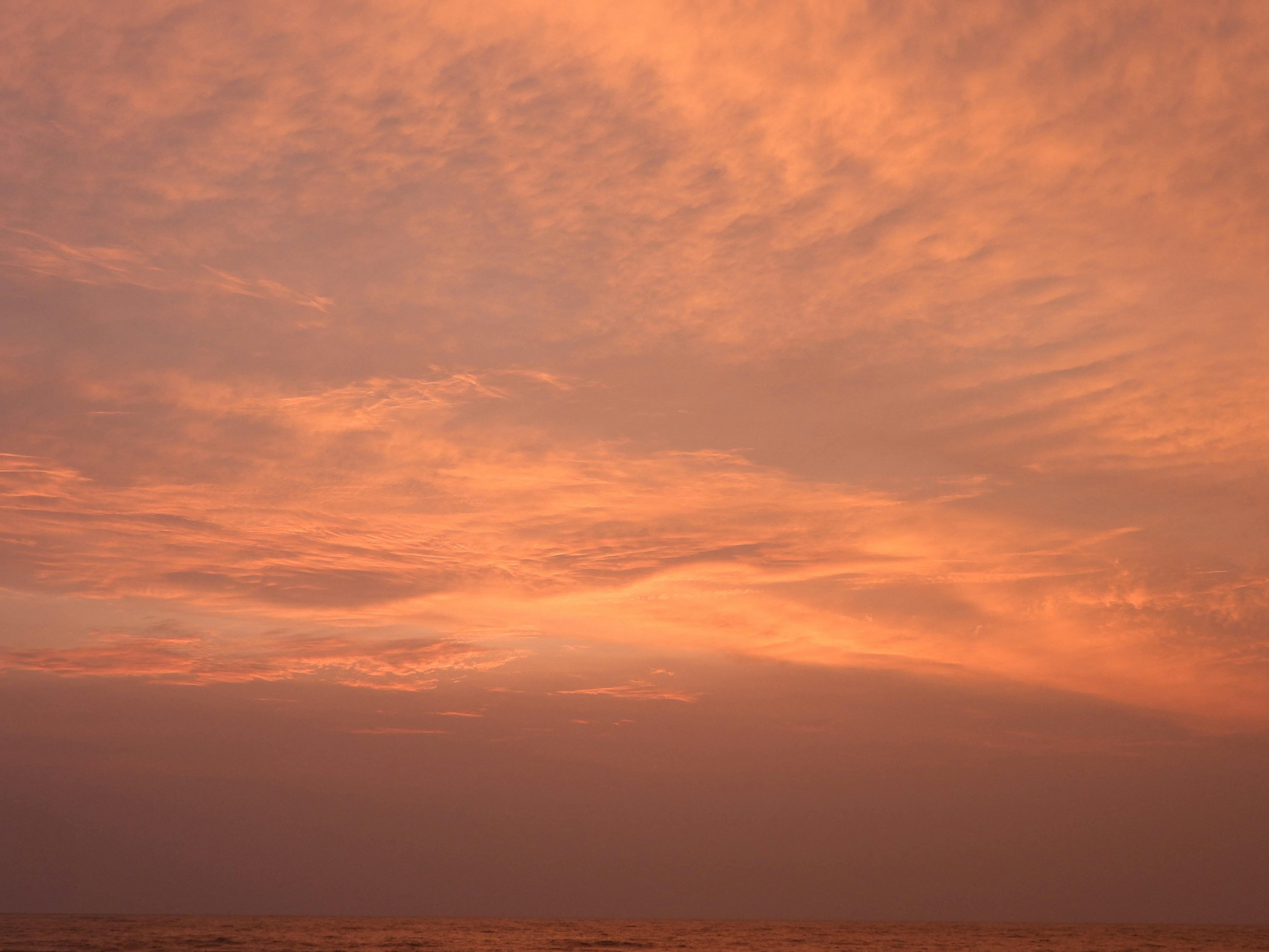 Quiet Horizon Ember: A Sunset Over Calm Seas
