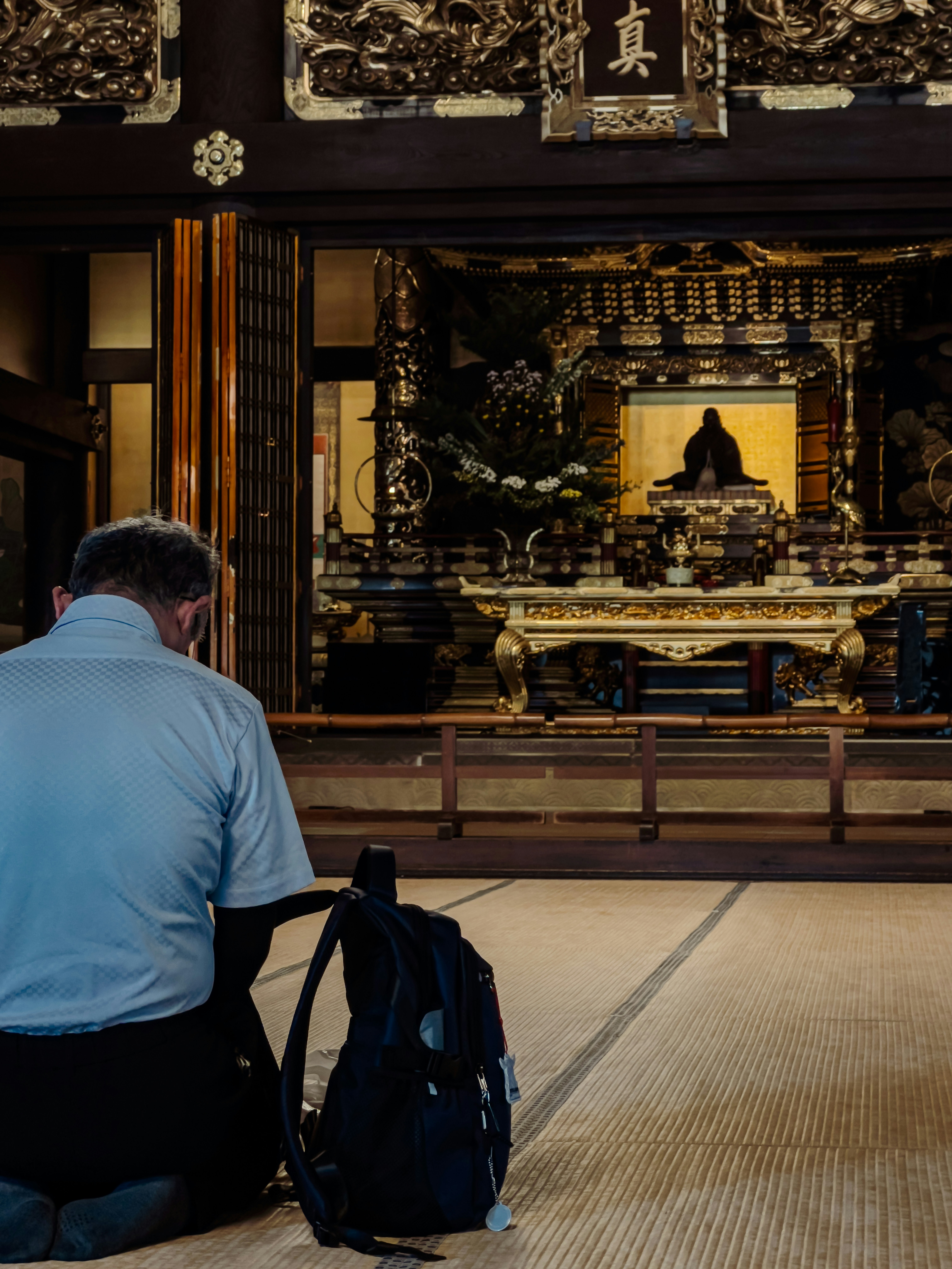 Kneeling Visitor Before the Golden Shrine