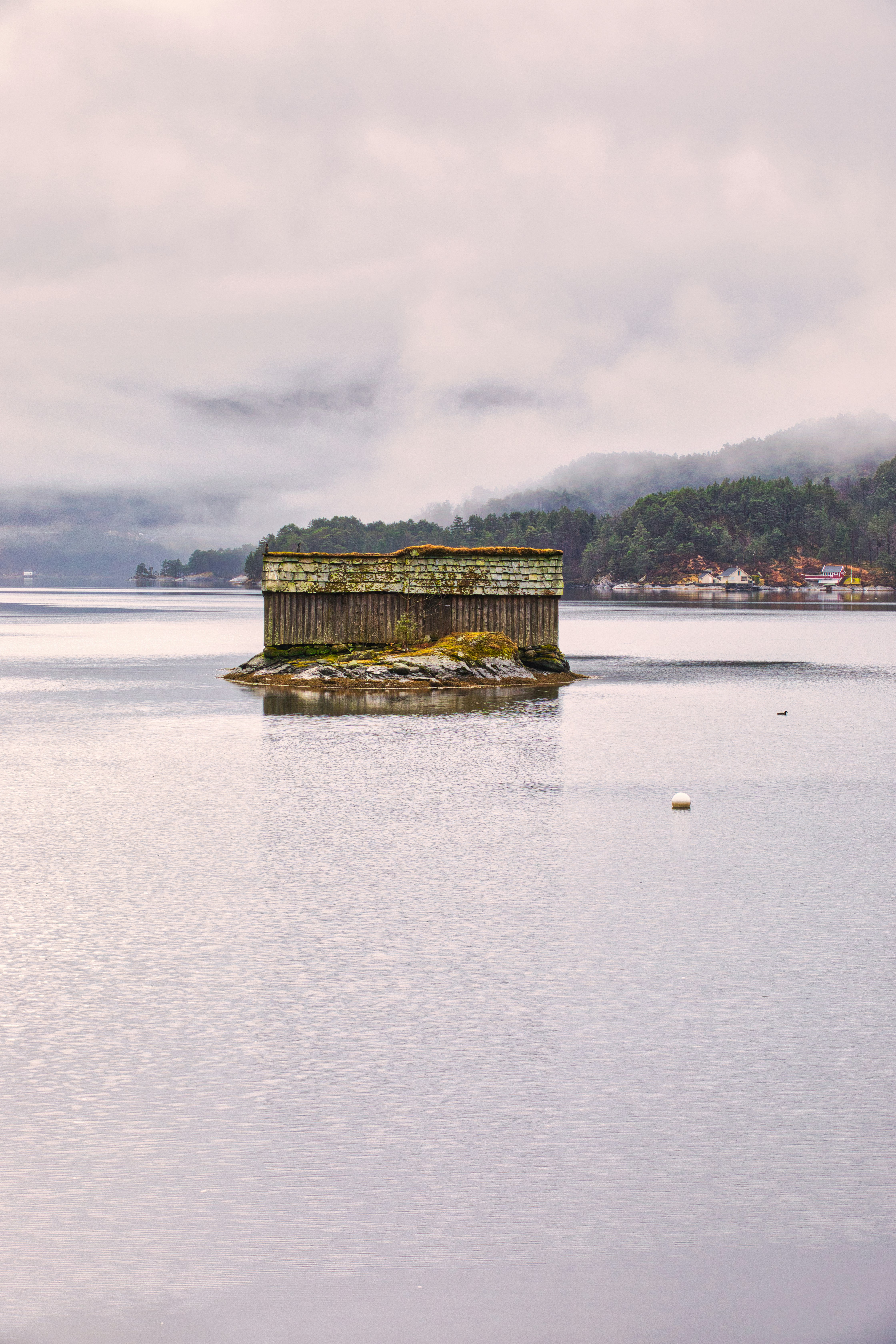 Isolated Pier Hut on a Serene Mirror Lake