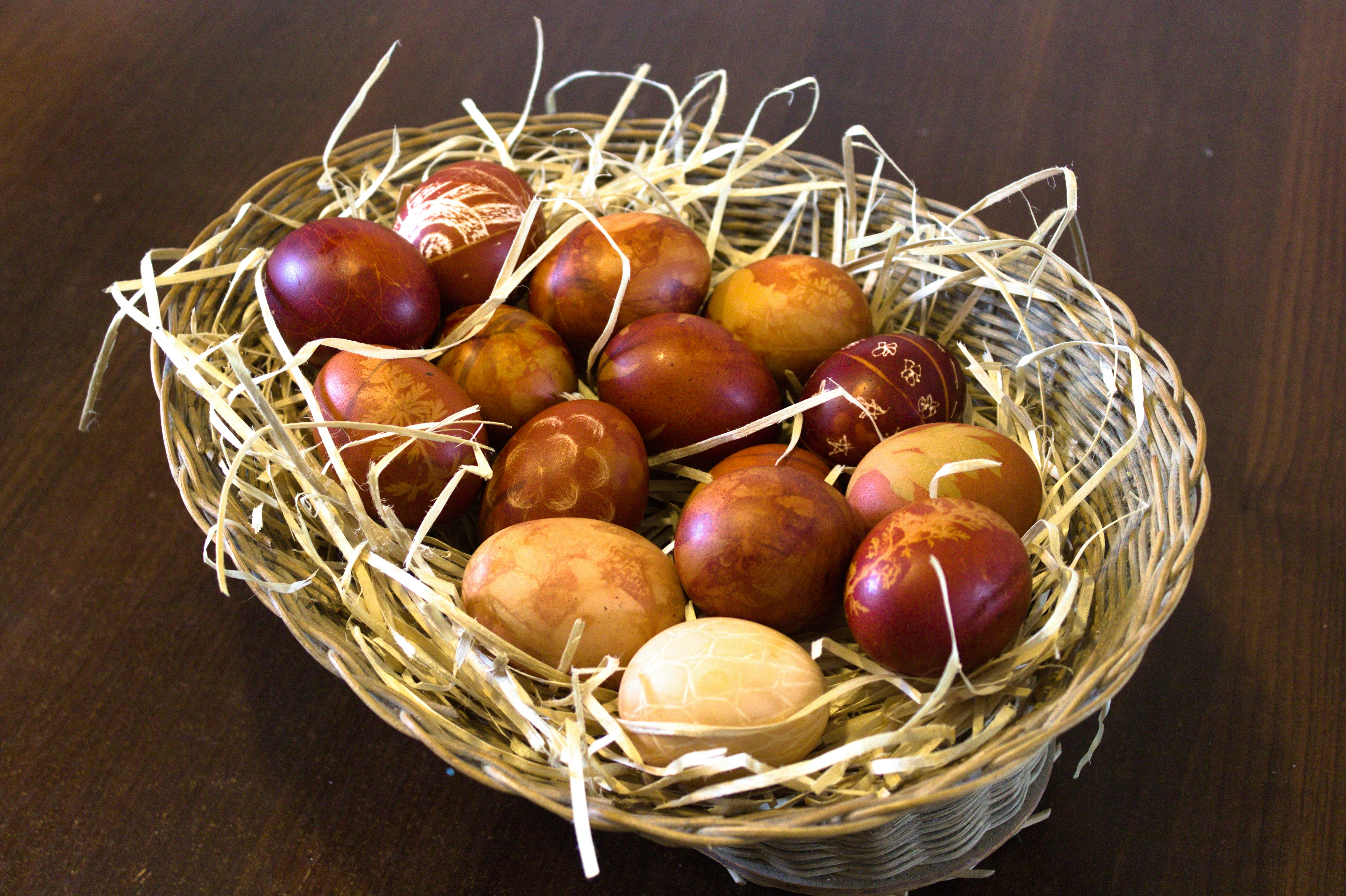 Nest of Painted Eggs: A Rustic Easter Basket on a Dark Wood Table