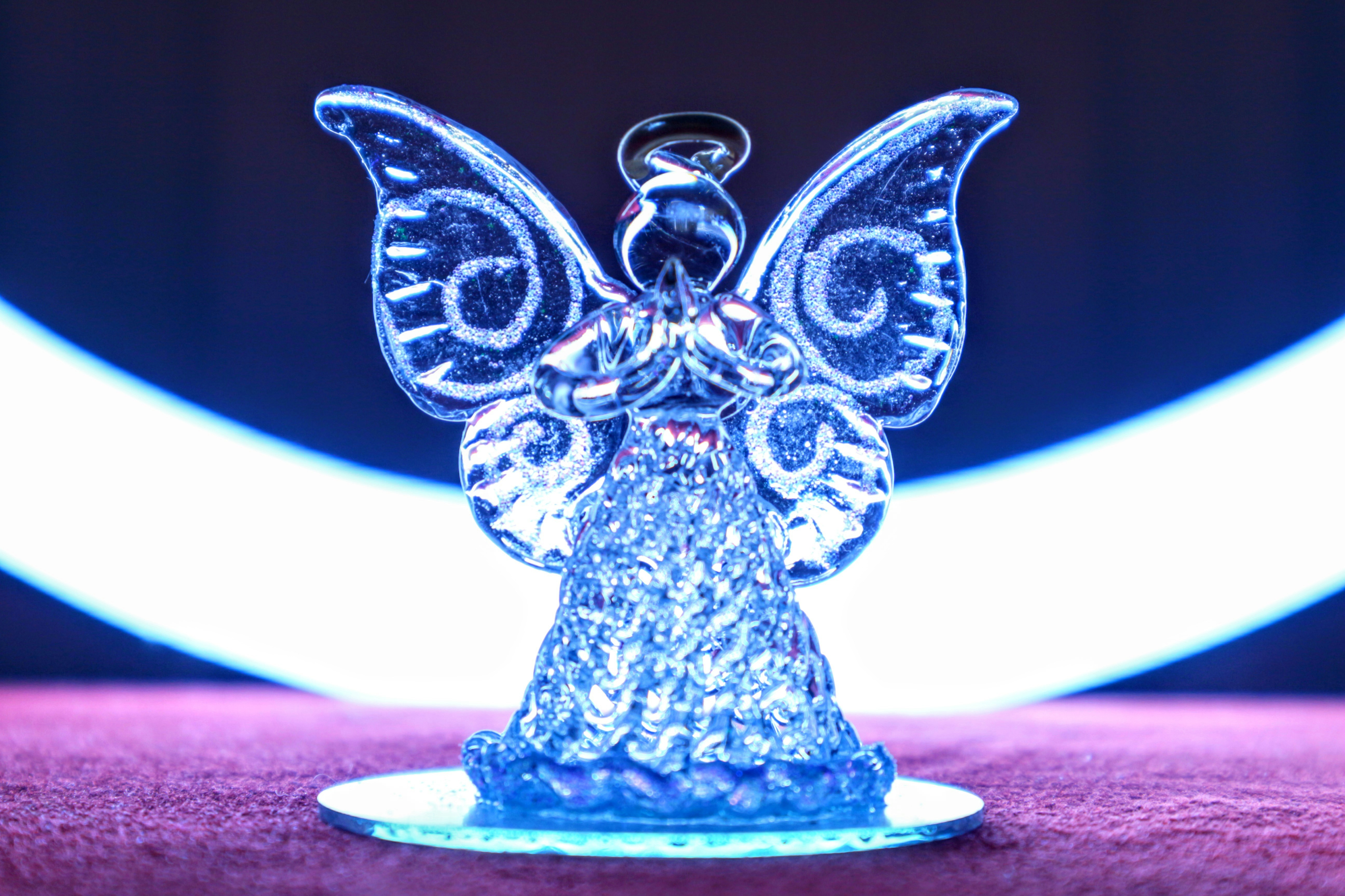 Crystal Angel: A Frozen Figurine Under Neon Spotlight