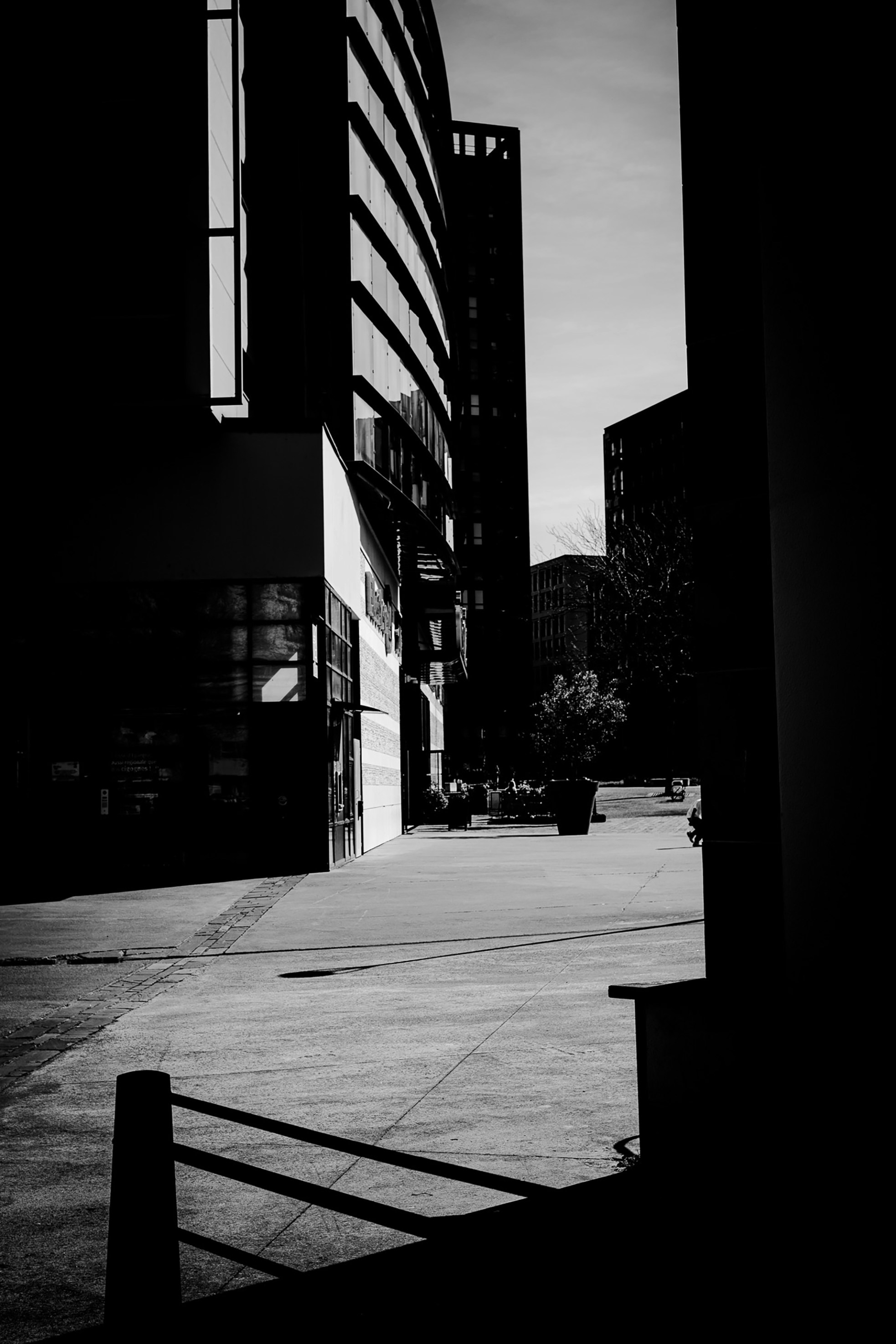Concrete Canyon: Light and Shadow Weave Through a Narrow Urban Atrium