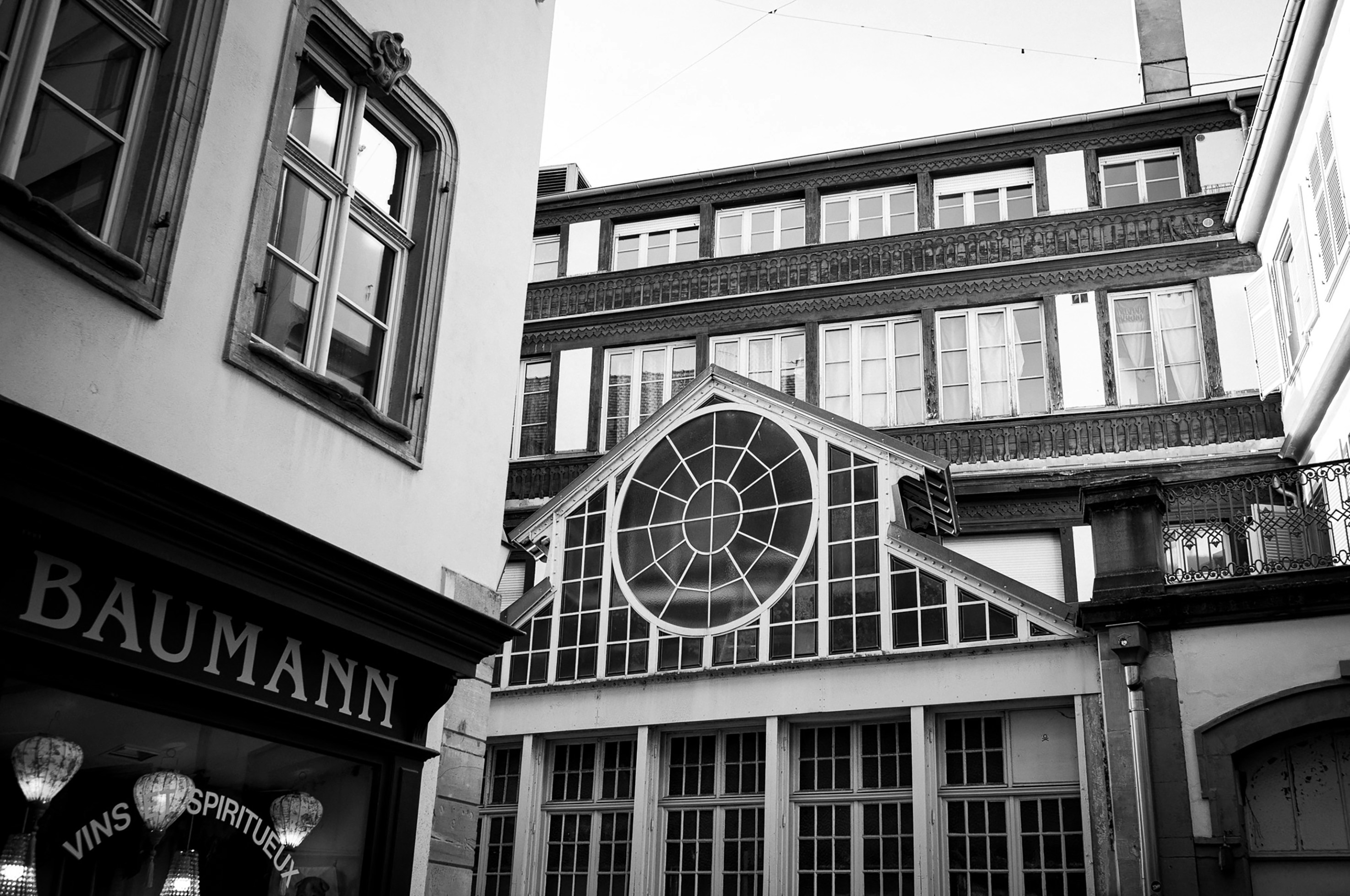 Historic Glasshouse Gables Framed by Urban Shopfronts