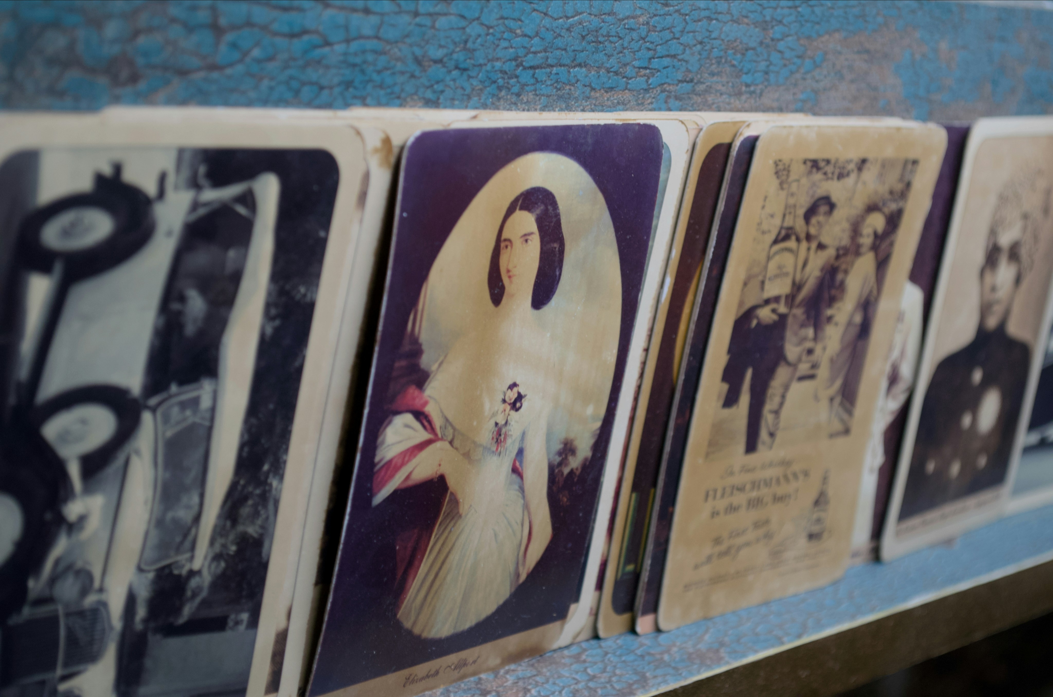 Iconic Shrine: A Row of Thematic Portrait Cards in a Weathered Display