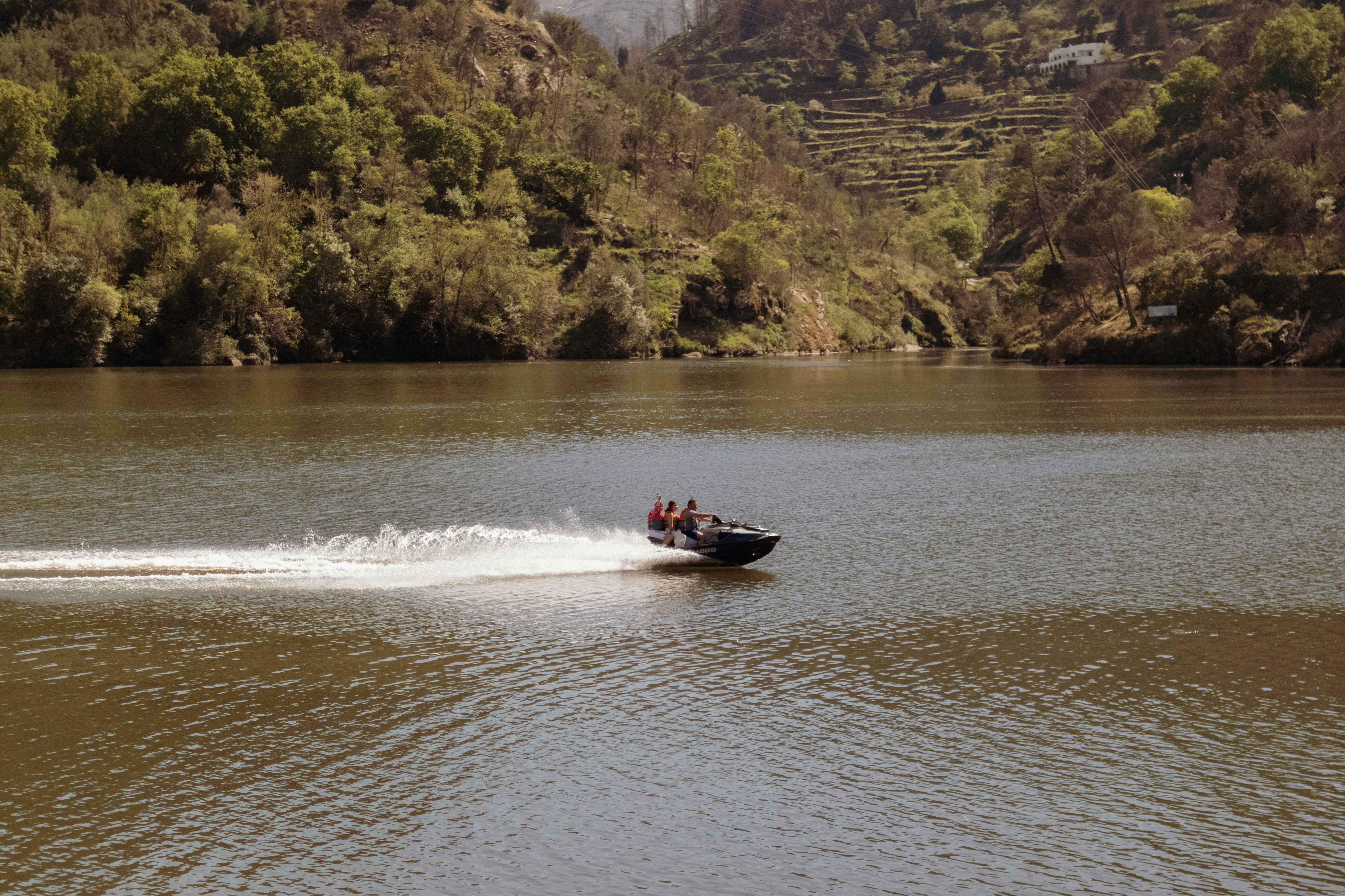 Jet on the River: A Narrow Wake Across Quiet Waters