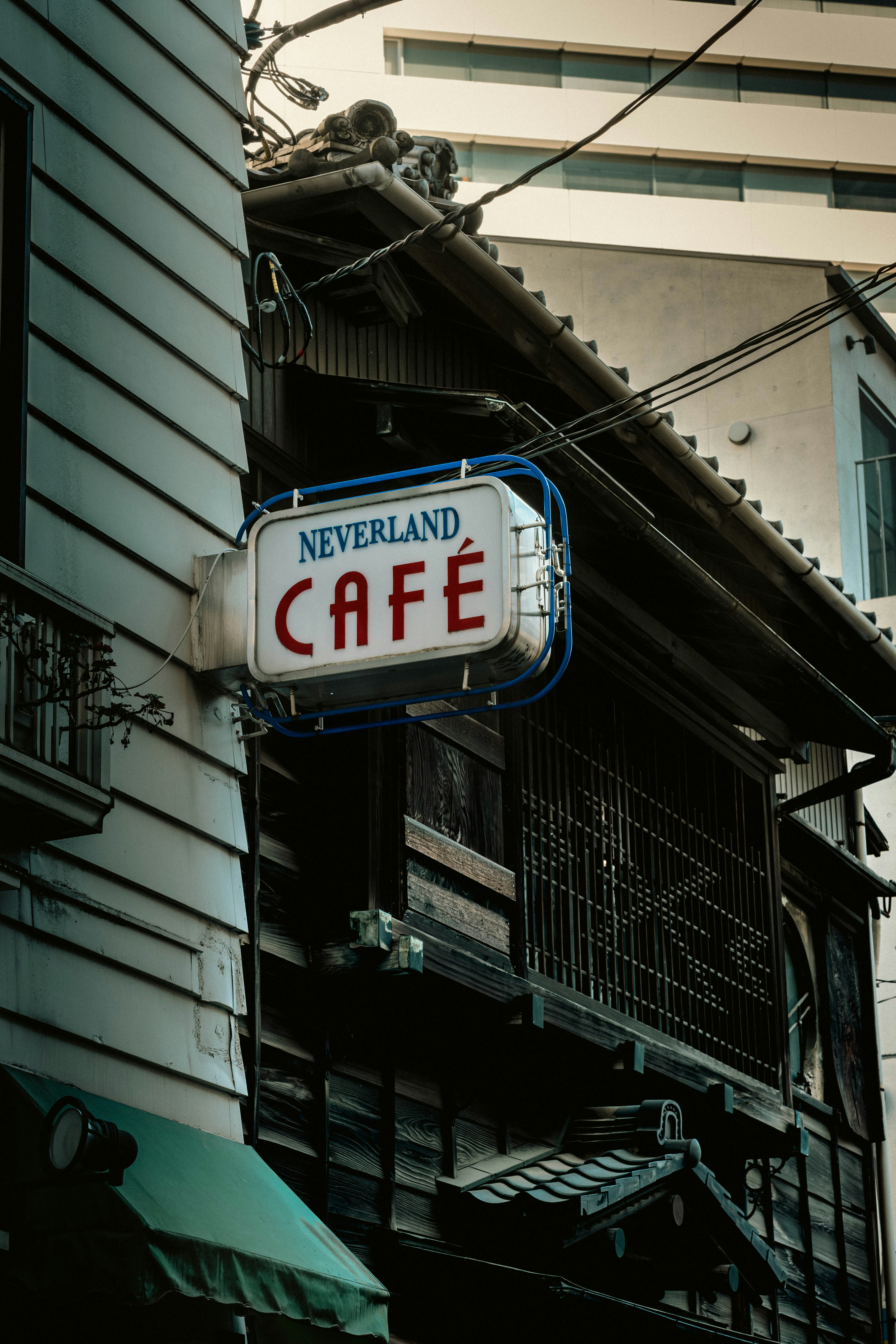 Neverland Café Sign Amid Vintage Architecture