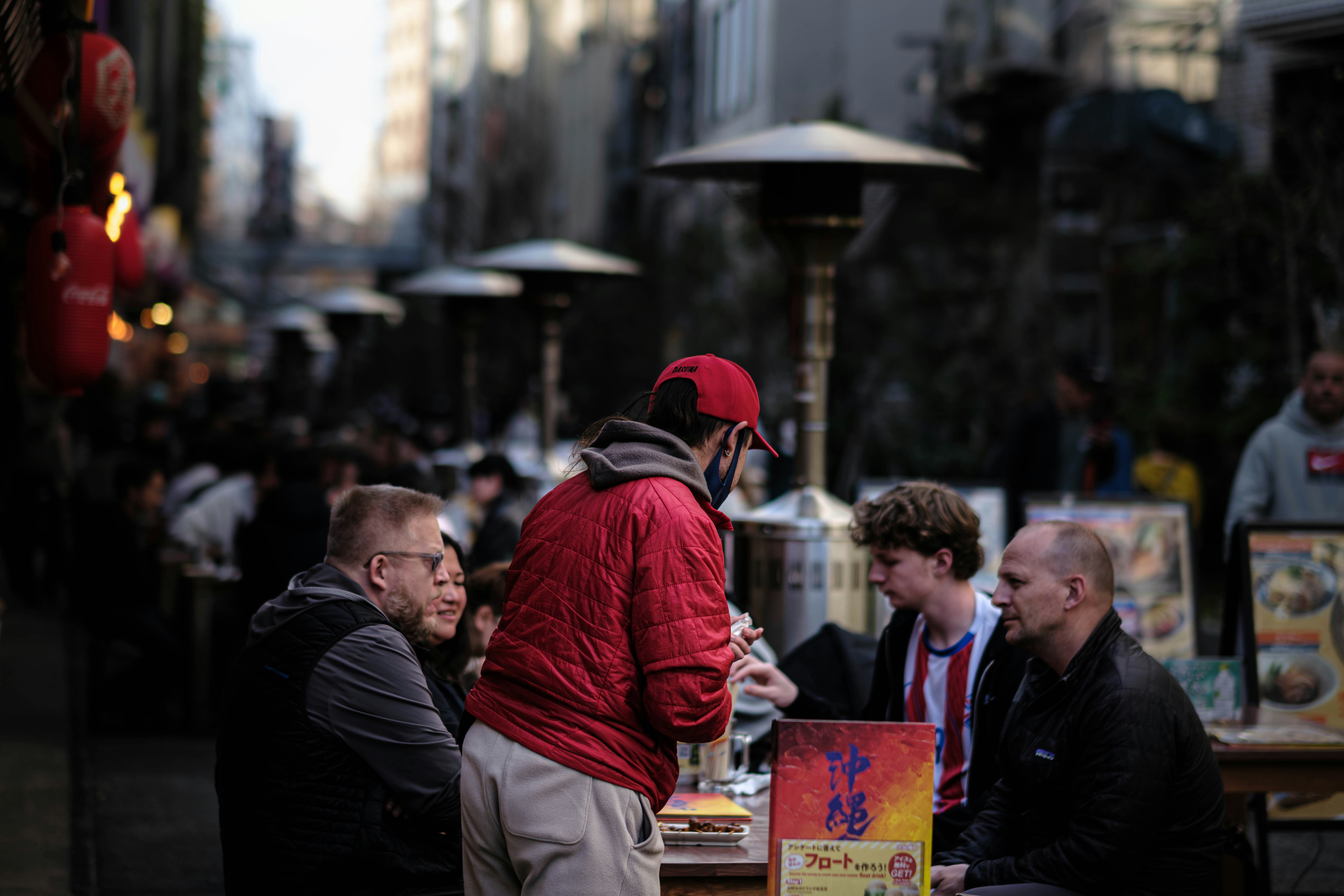 Red-Jacketed Messenger at a Street Café Exchange