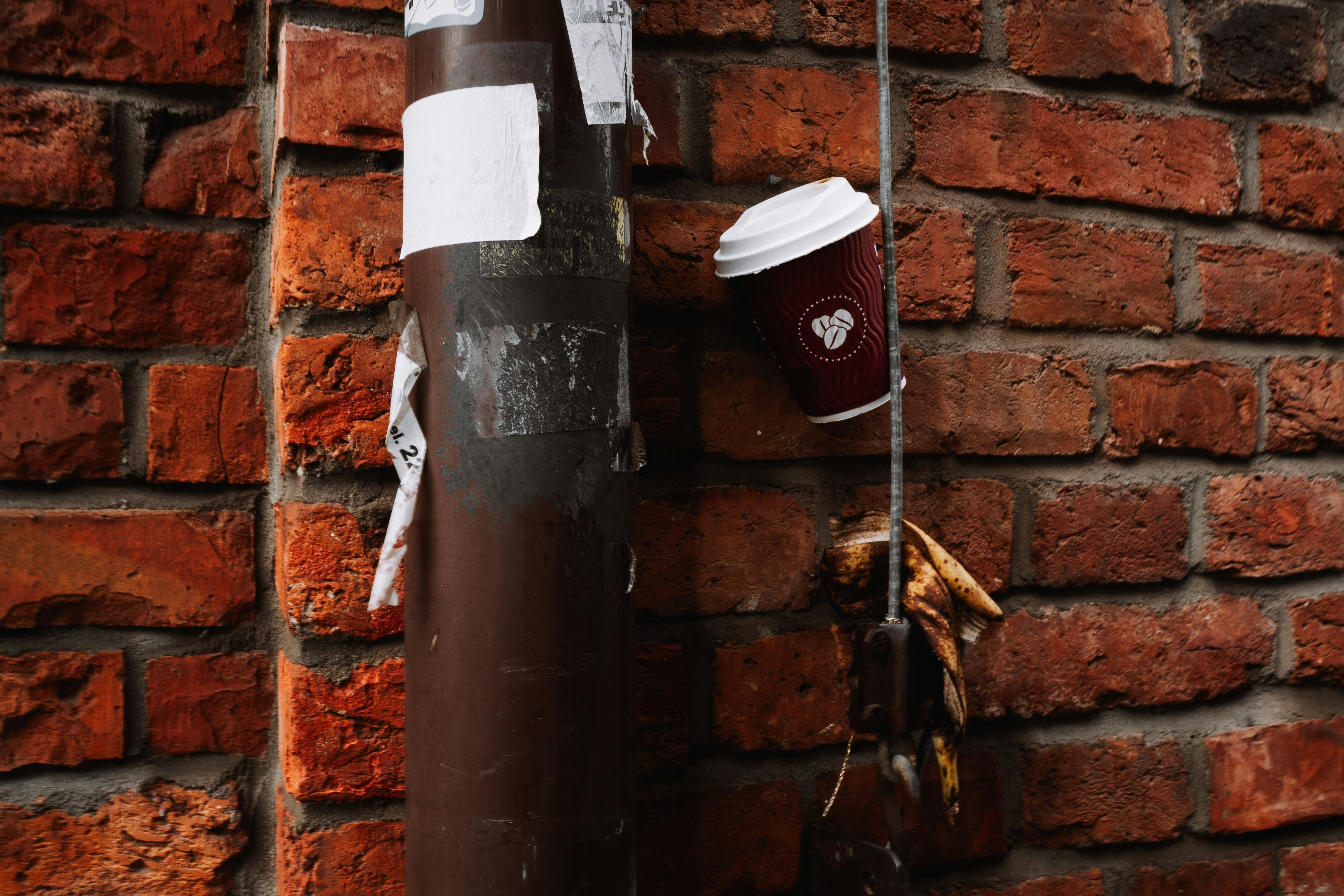Coffee Clings to the Bricks: A Street-Side Moment