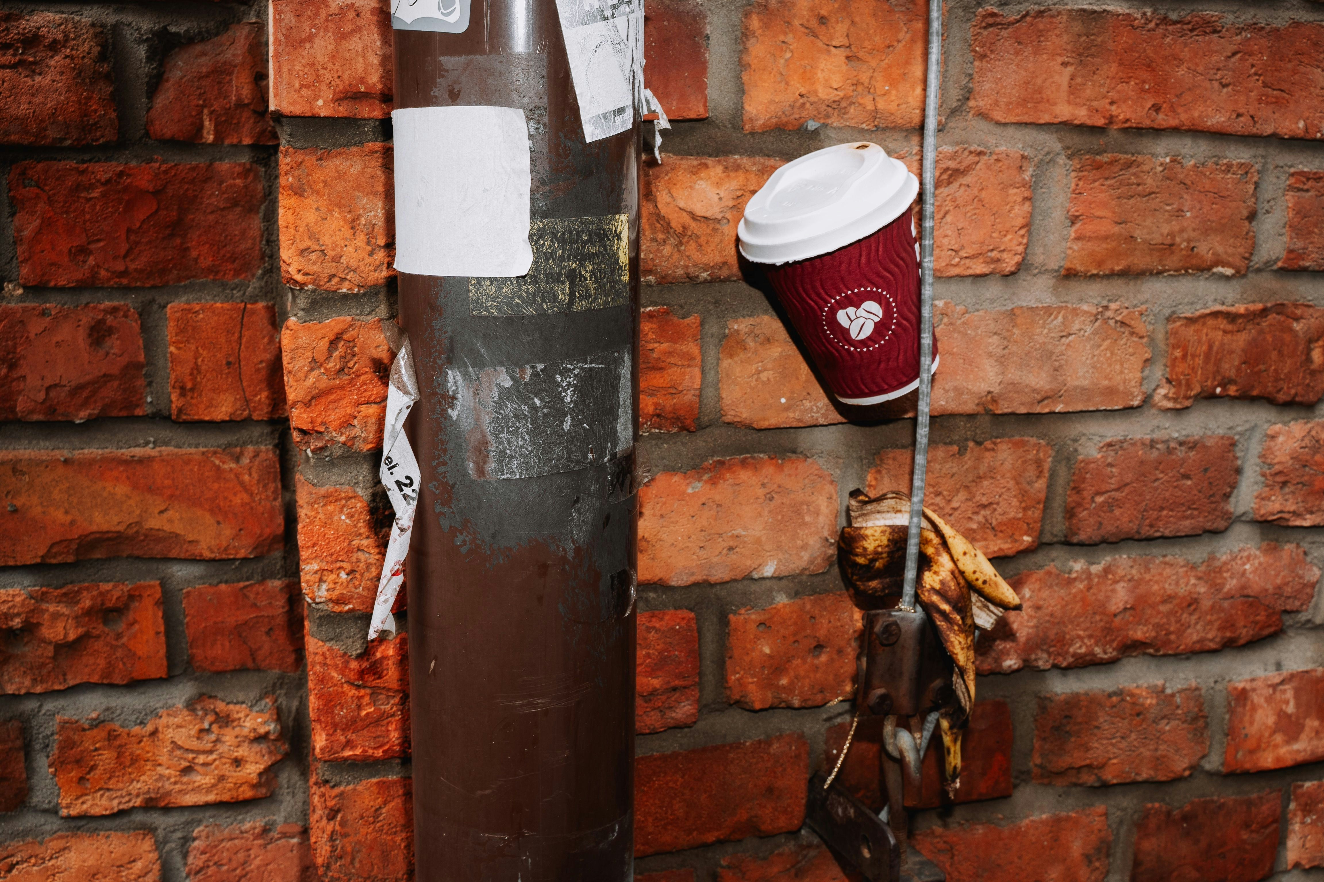 Coffee Cup Dangles on a Bricked Corner