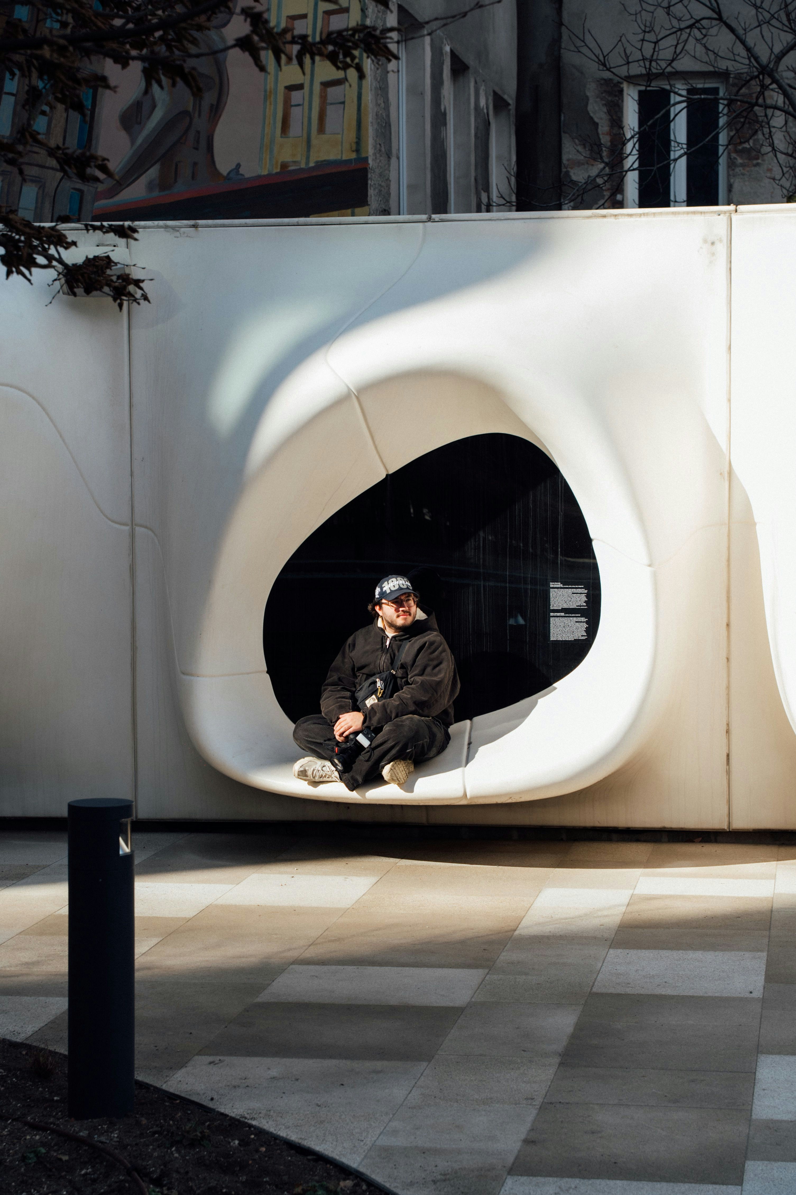 Seated in the White Macropod: A Quiet Moment in an Architectural Capsule