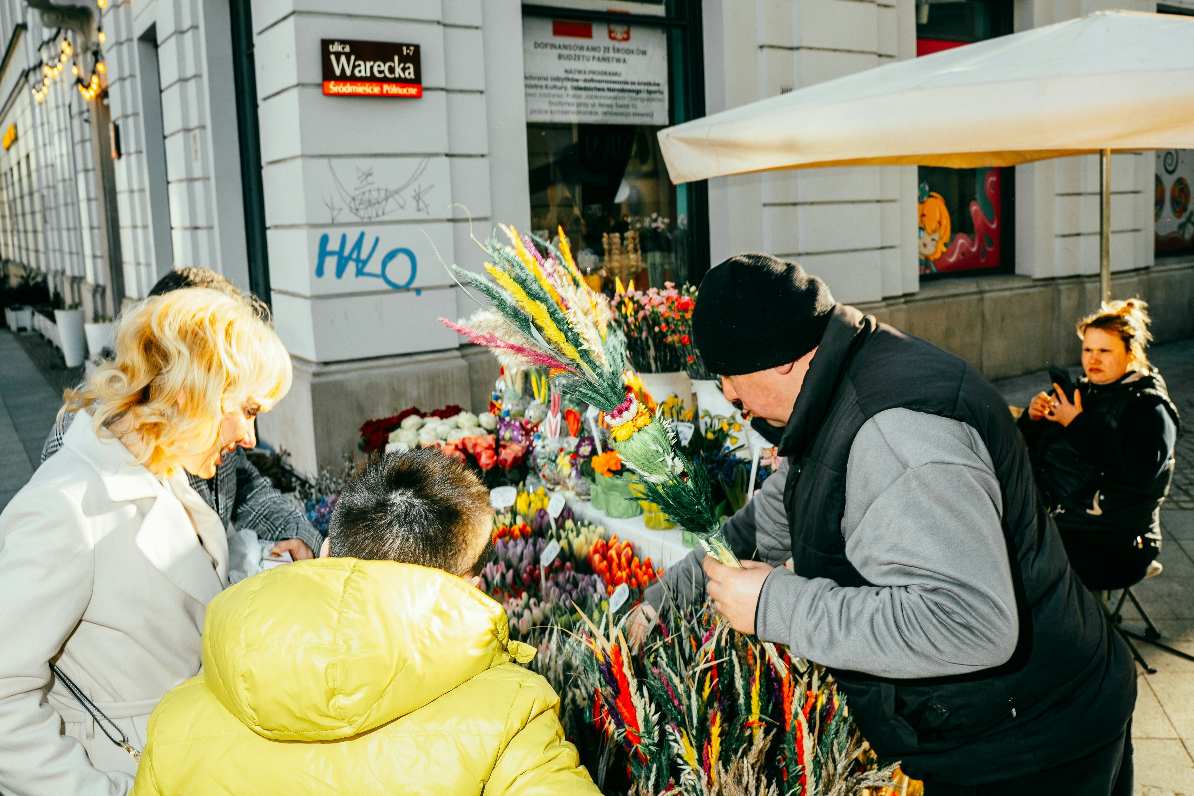 Vendors and Bouquet Drafts Along a City Sidewalk