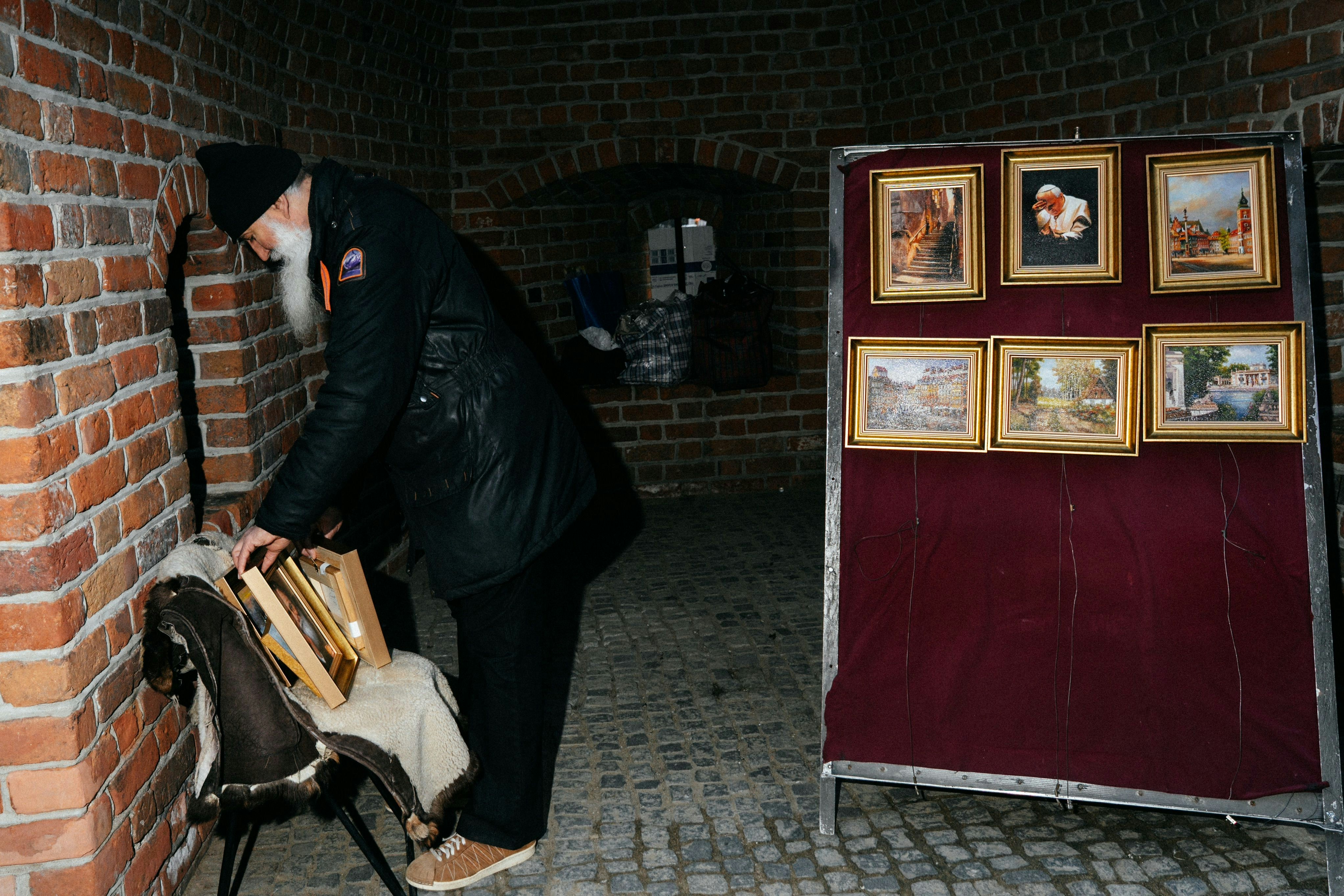 Whispers in the Gallery: A Night Visitor examinining framed memories