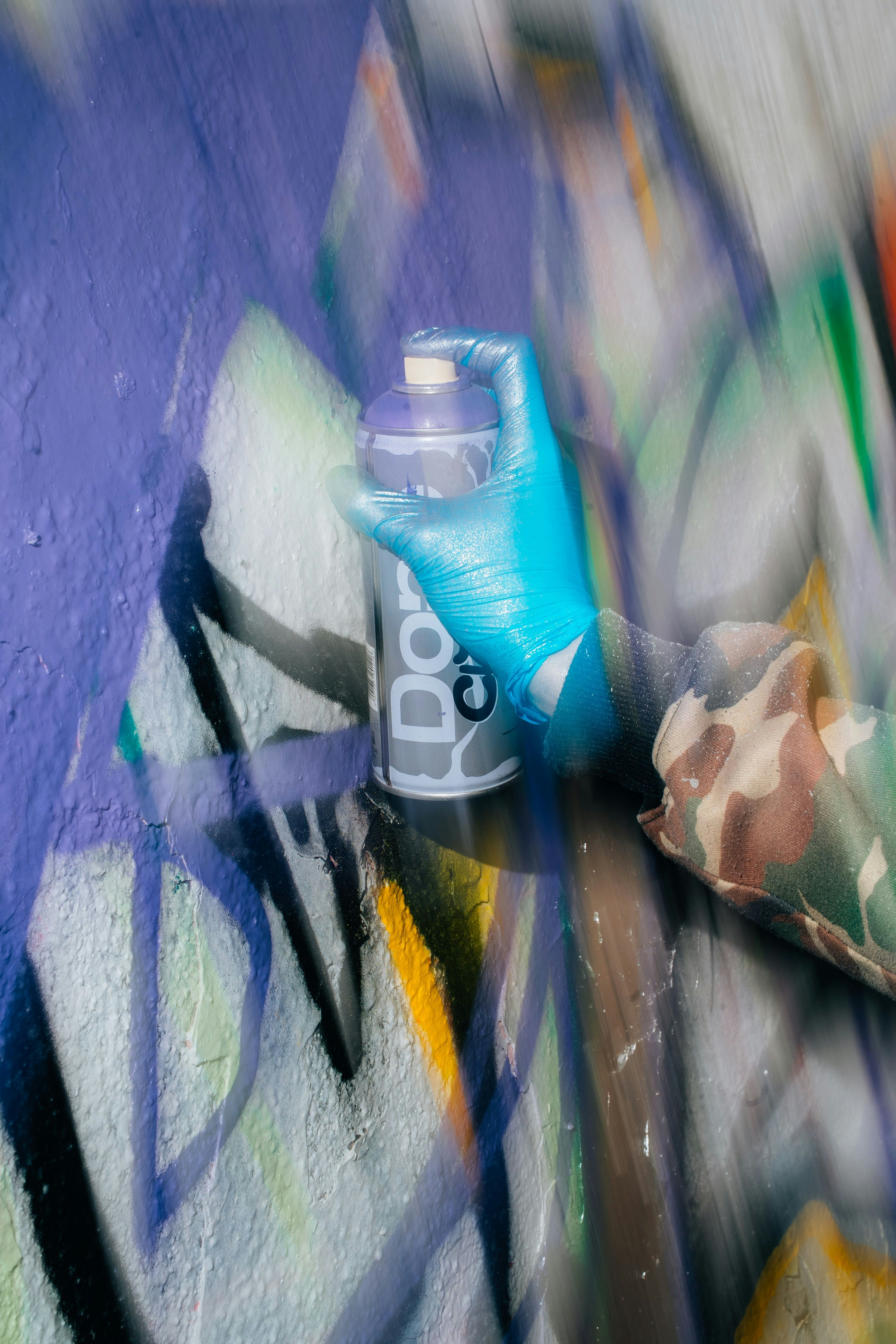 Gloved Grip: The Spray Can Clutched Against Graffiti