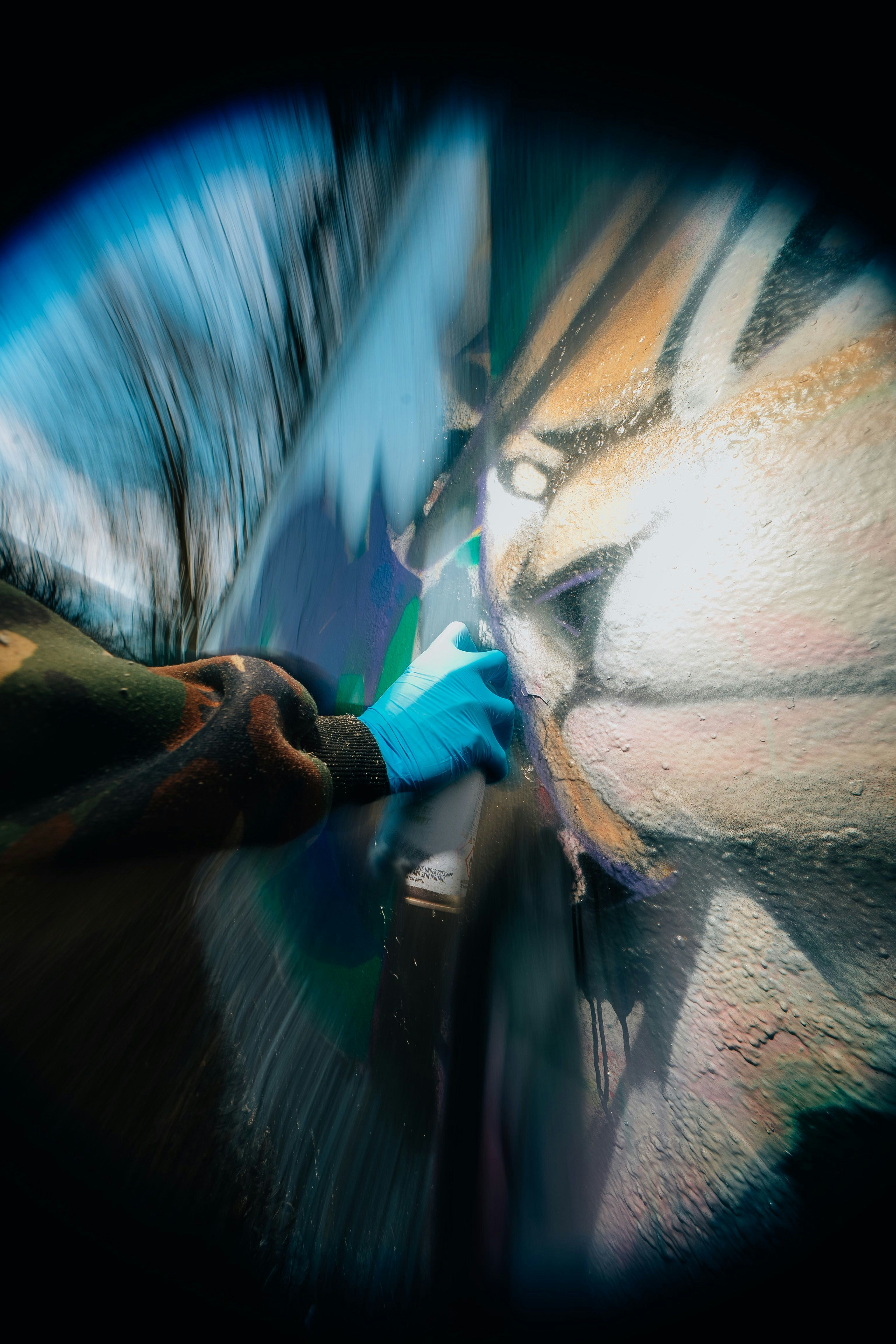 Gloved Hand in Motion: Graffiti Spray and Blur