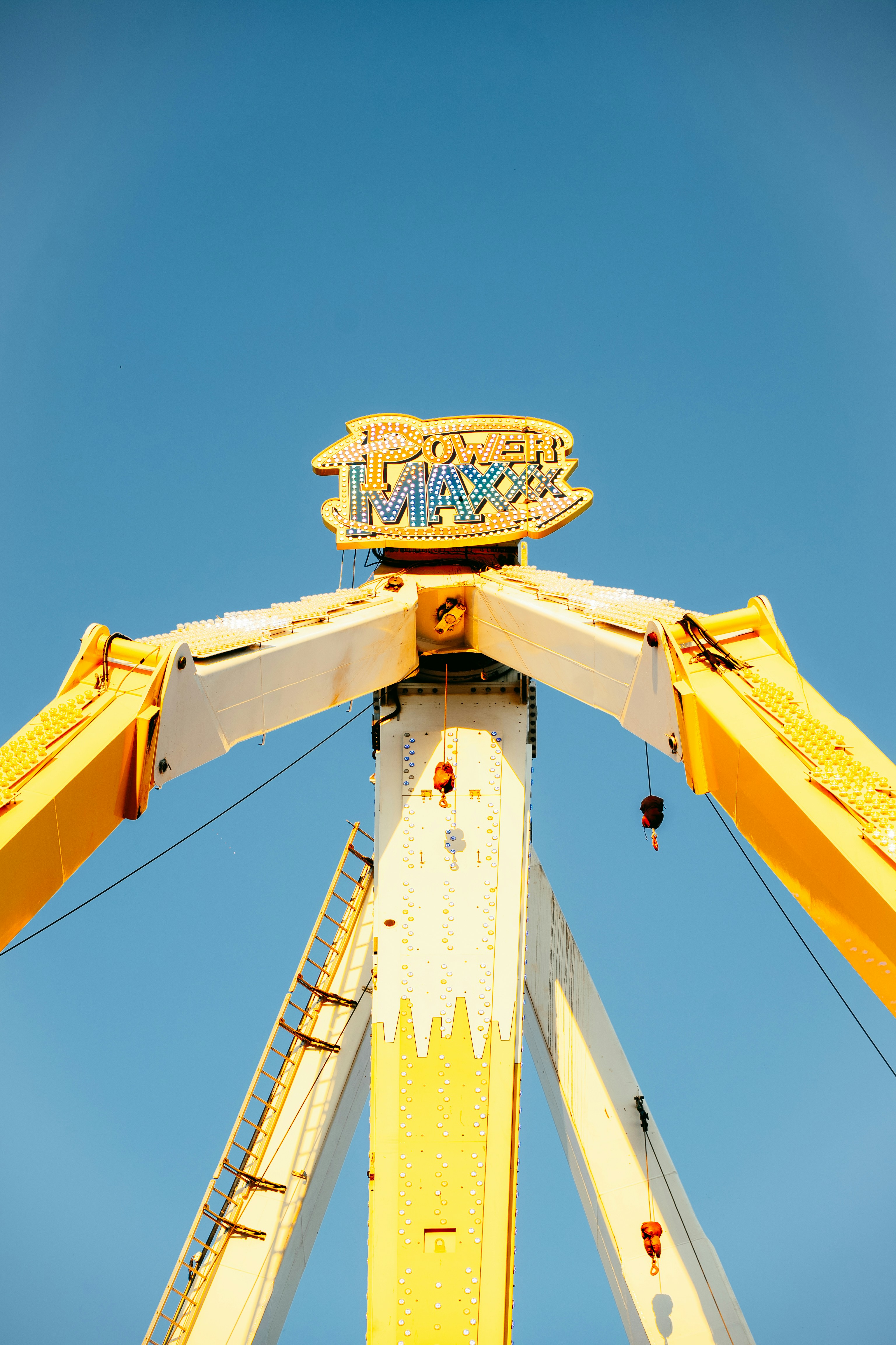 Golden Crane Arms Reaching Toward a Bright Sky