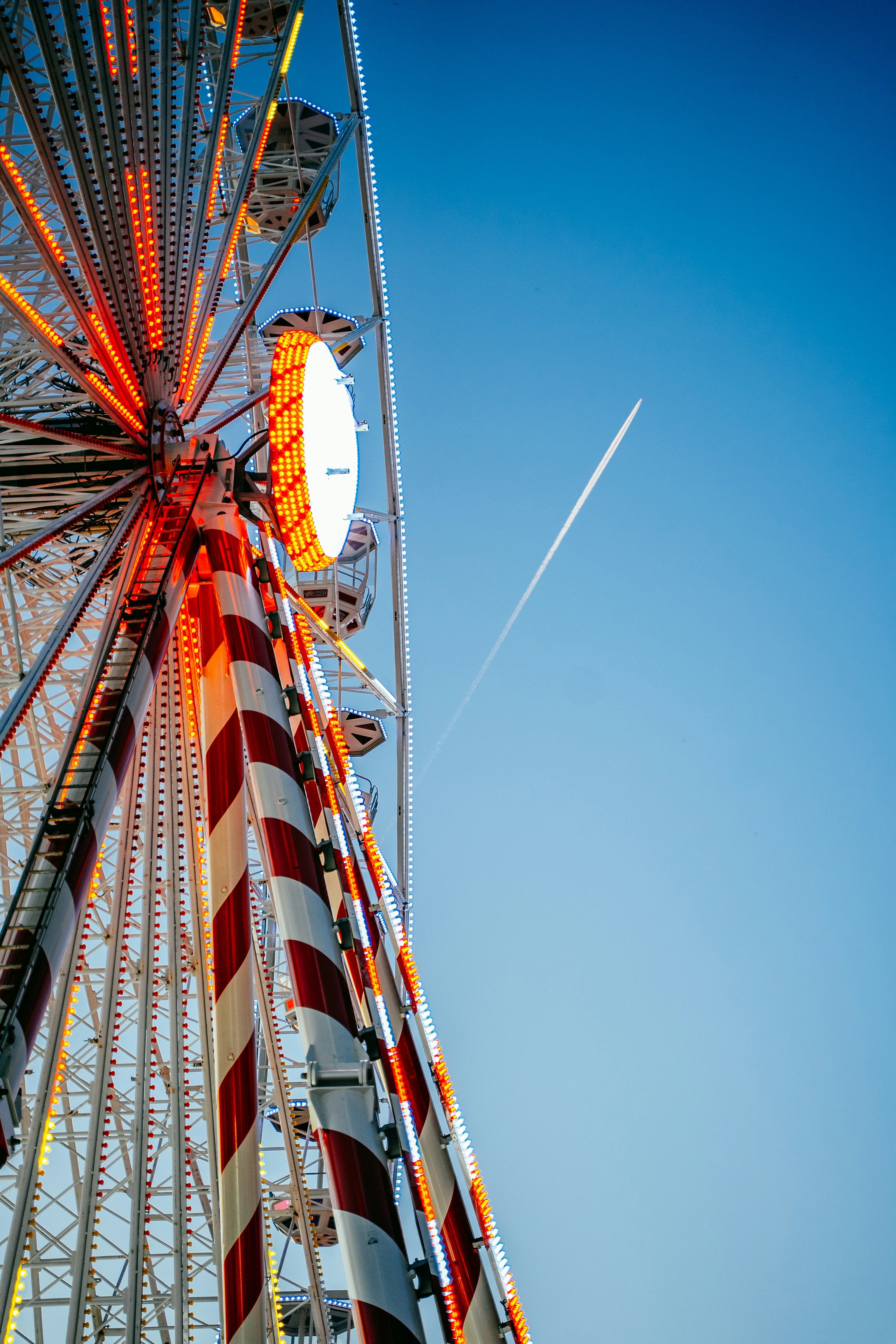 Ferris Wheel Glow: Neon Stripes Against a Clear Blue Sky