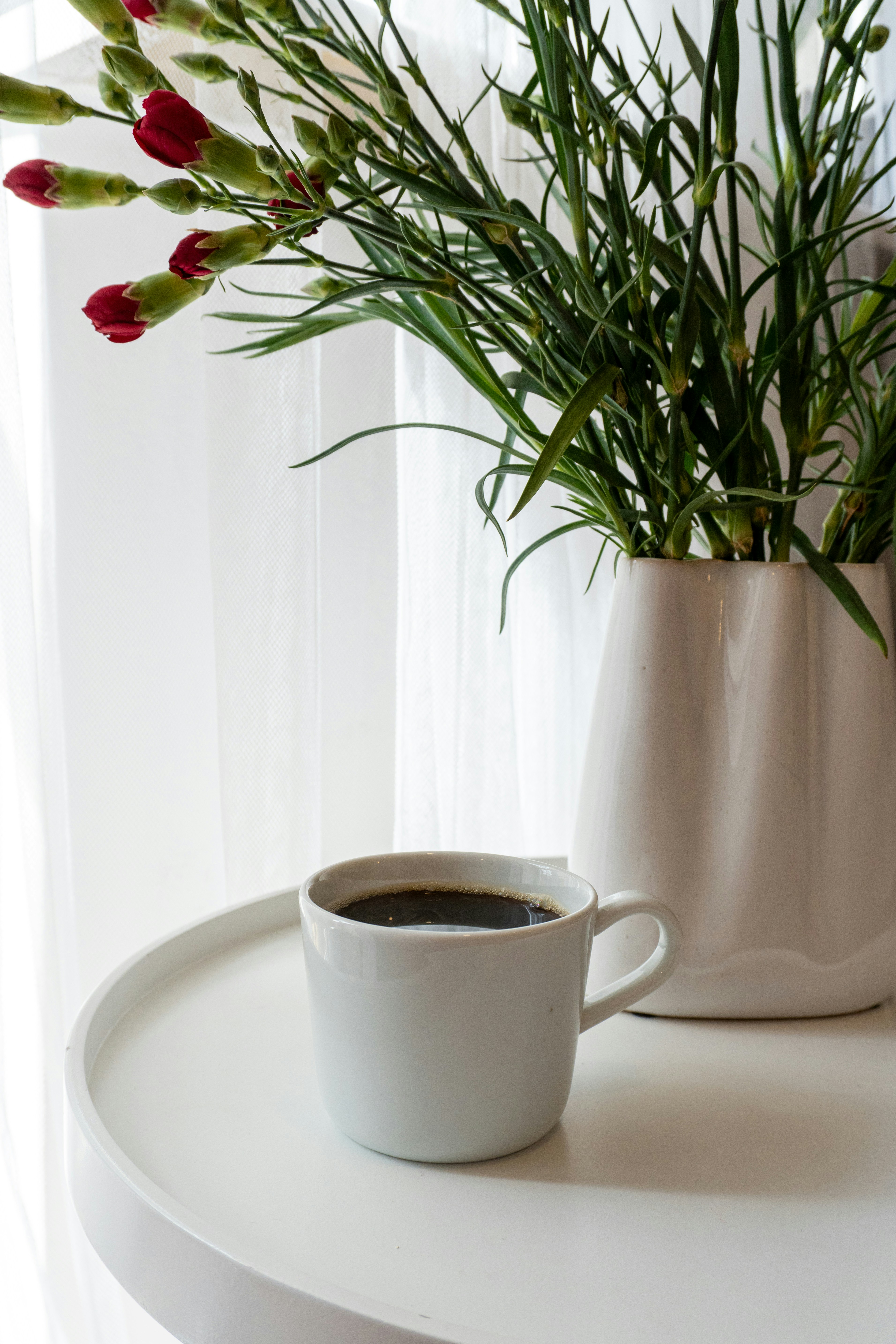 Morning Brew by the Window: A Cup and White Flowers