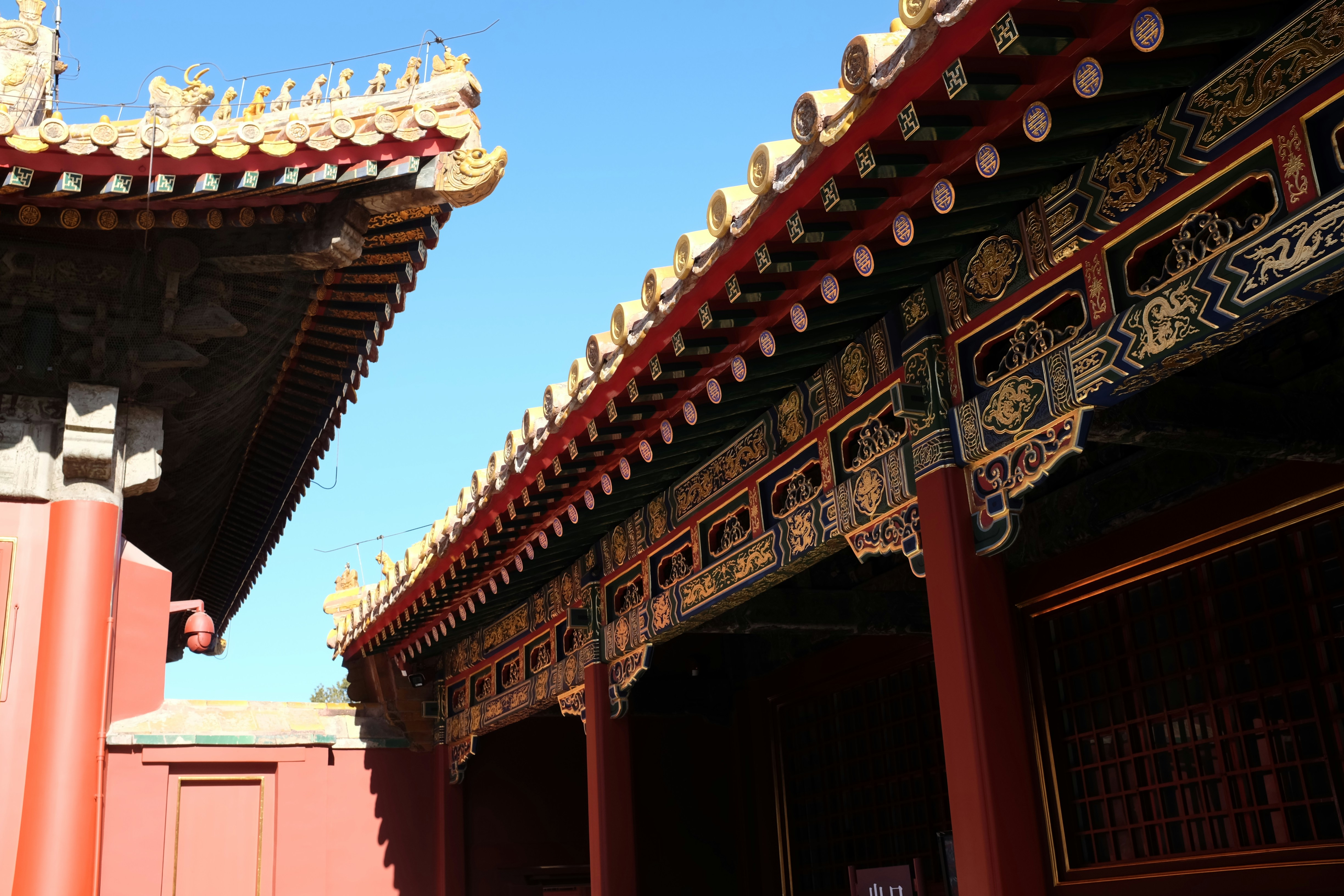 Ornate Eaves: Sunlit Ridge in a Chinese Temple Courtyard