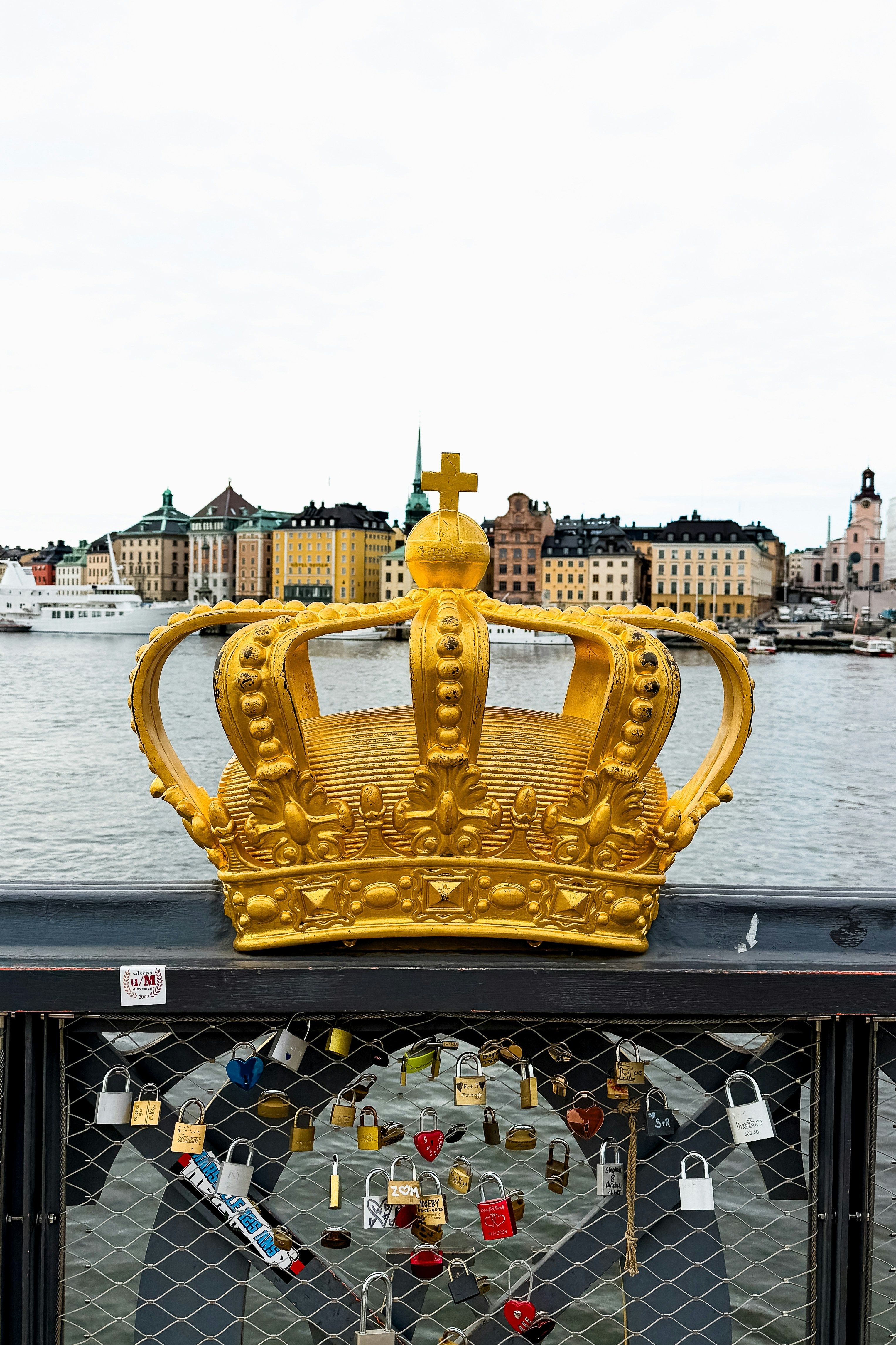 Golden Crown Over a Padlocked Bridge