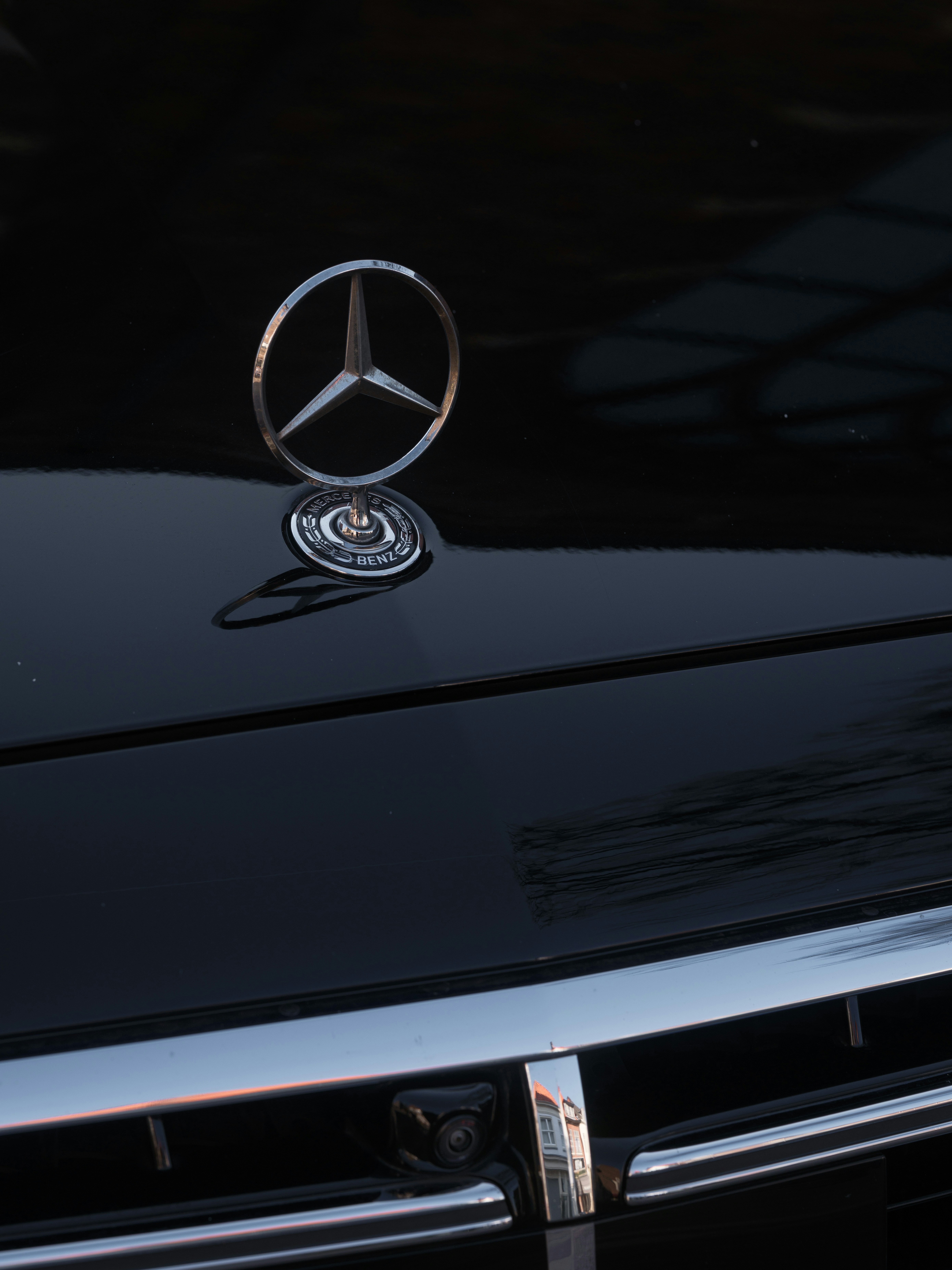 Mercedes Emblem: Quiet Reflection on a Midnight Hood